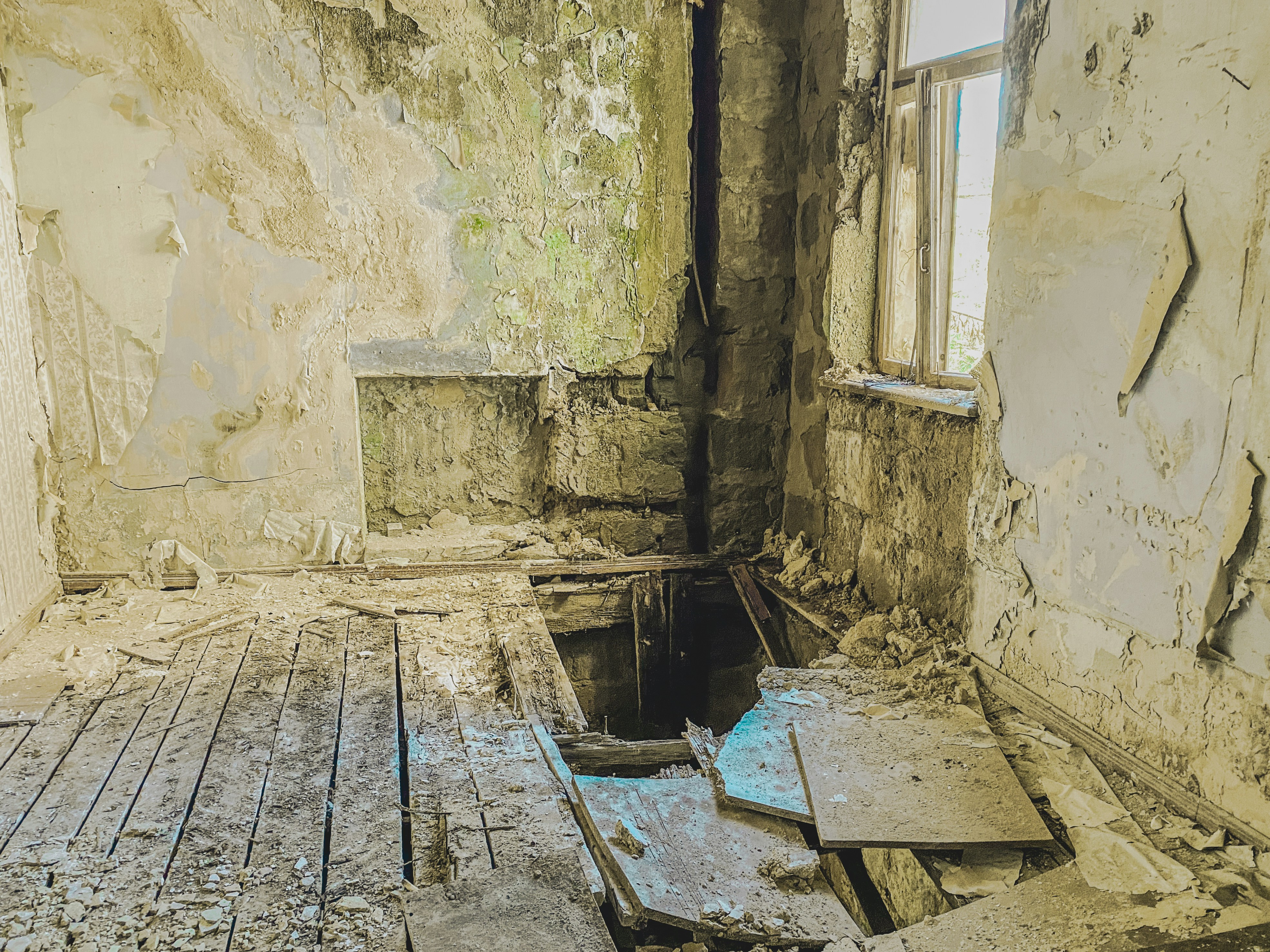 A run down room with a hole in the floor photo – Free Punctured Image ...