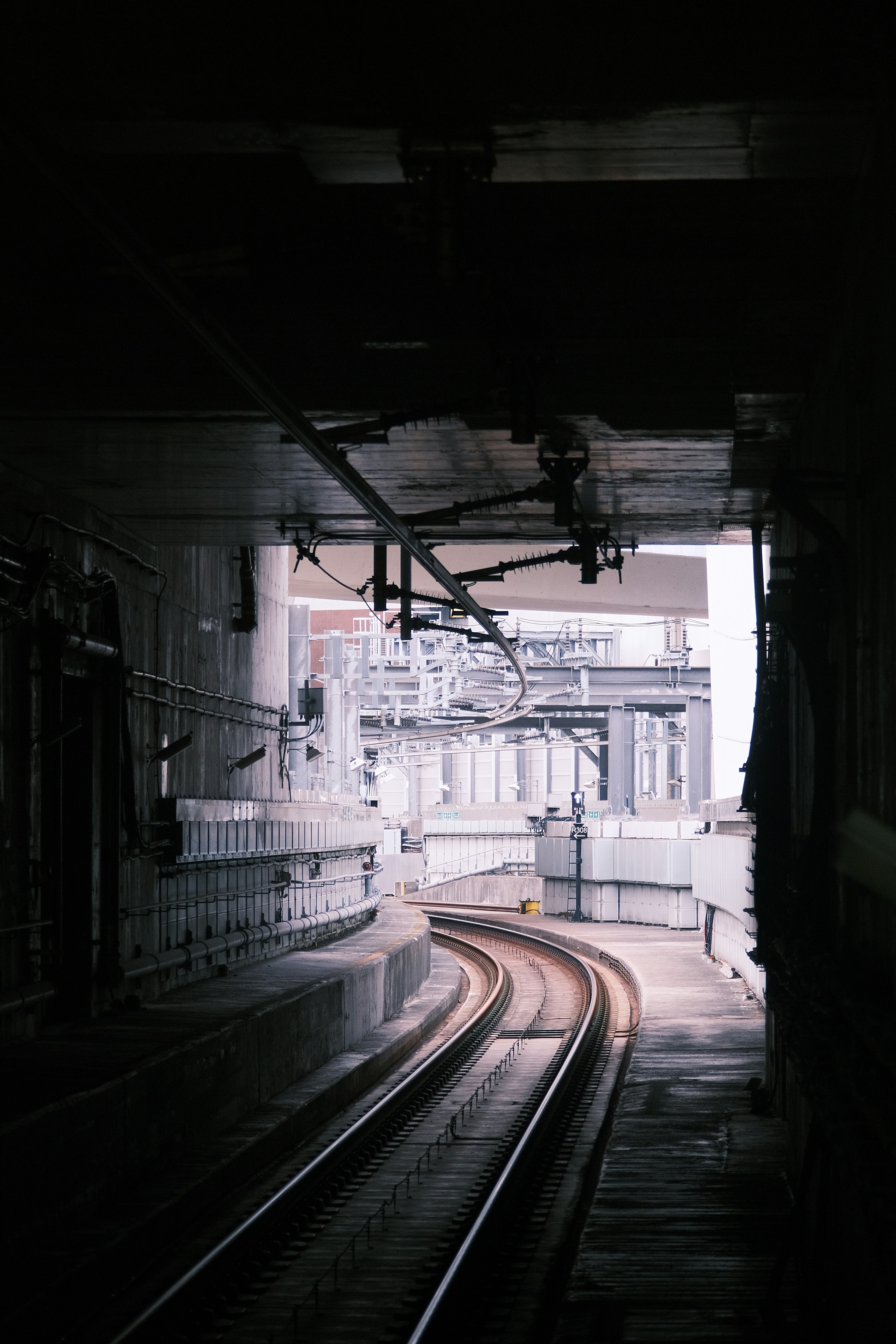 A train track going through a tunnel with buildings in the background ...
