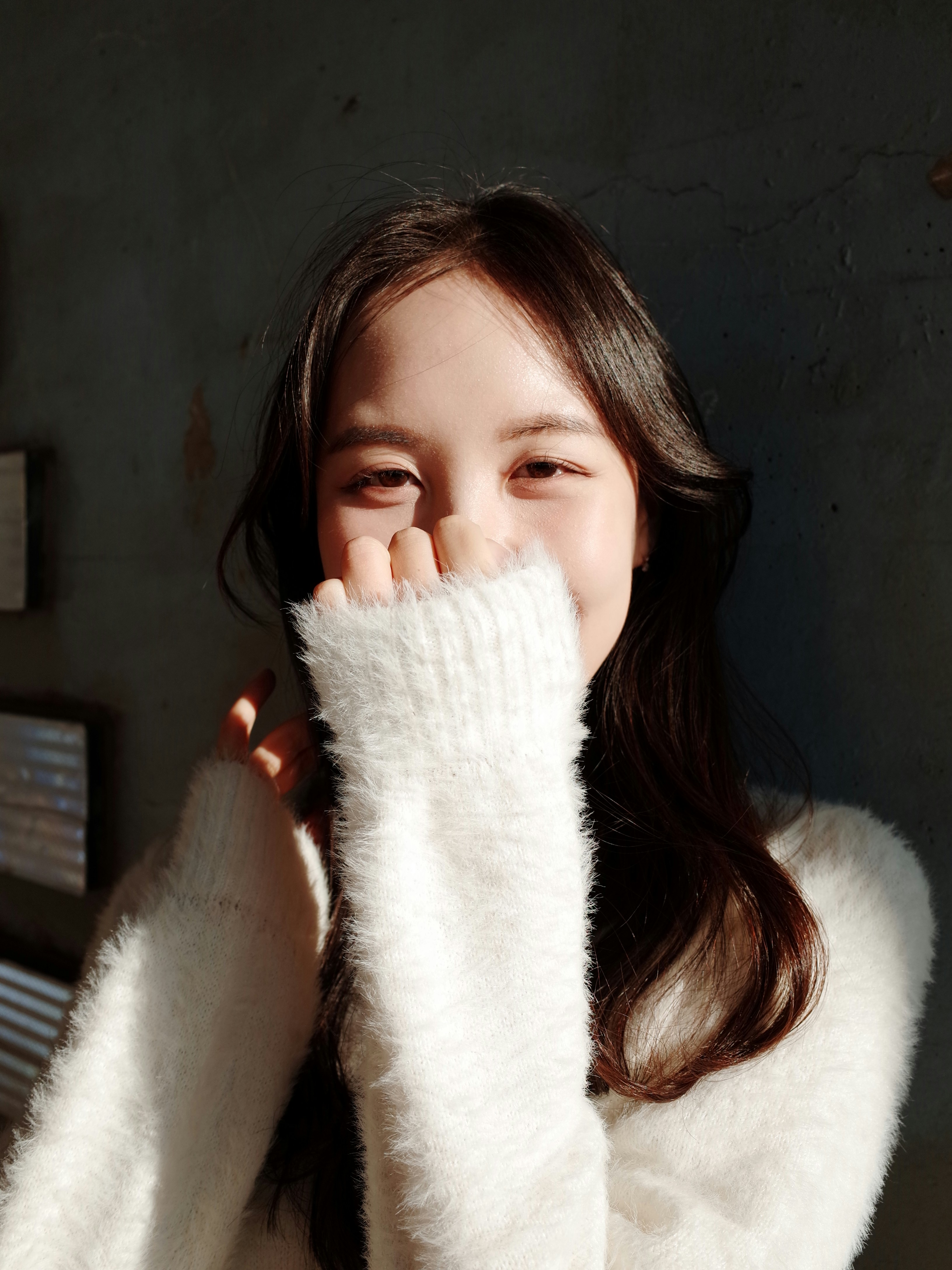 A girl in a white coat covers her face with her hands photo – Free Face ...