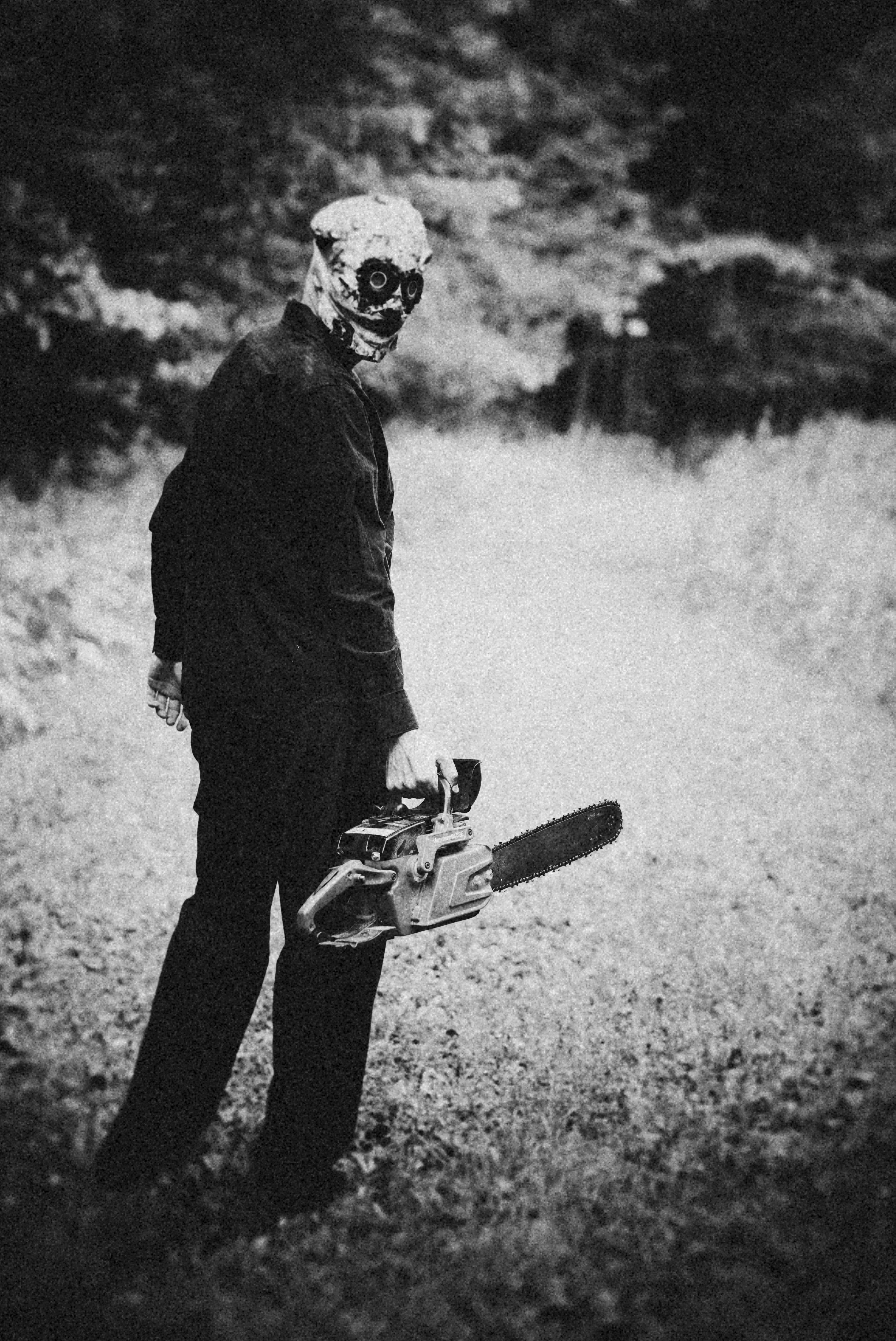 A skeleton holding a skateboard on a dirt road photo – Free Dark ...