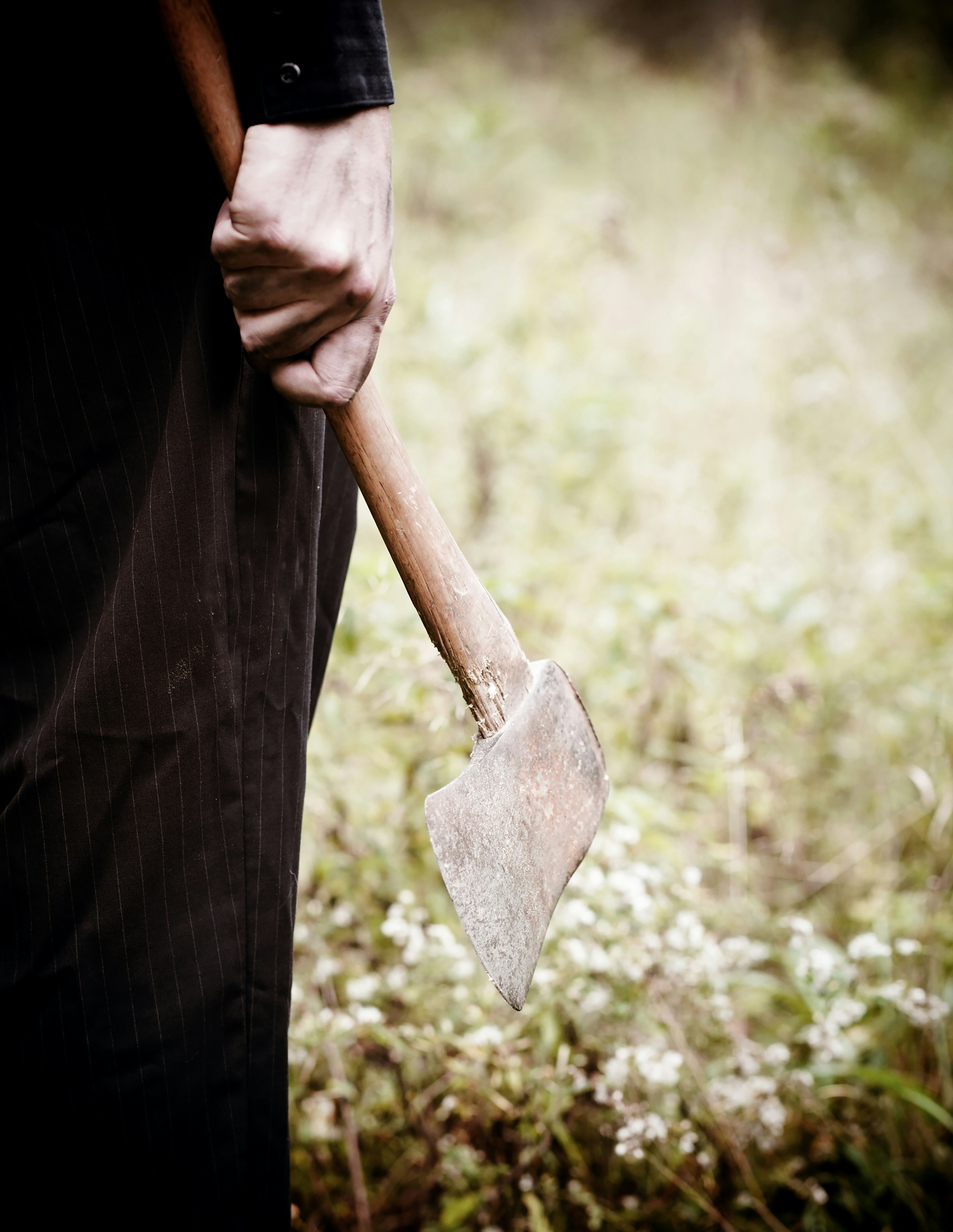 A man holding a shovel in a field photo – Free Axe Image on Unsplash