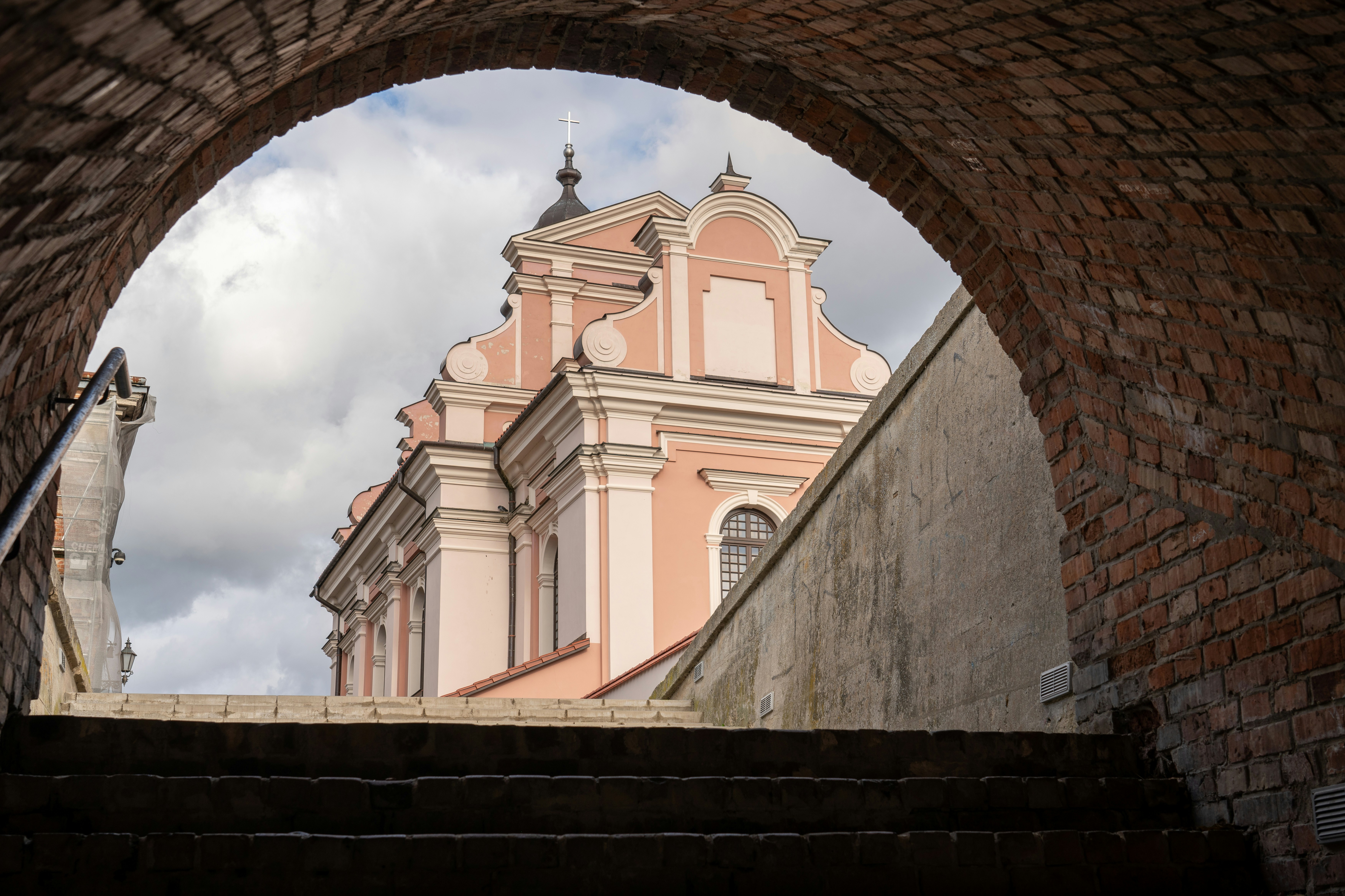 A view of a building through an archway photo – Free Zamość Image on ...