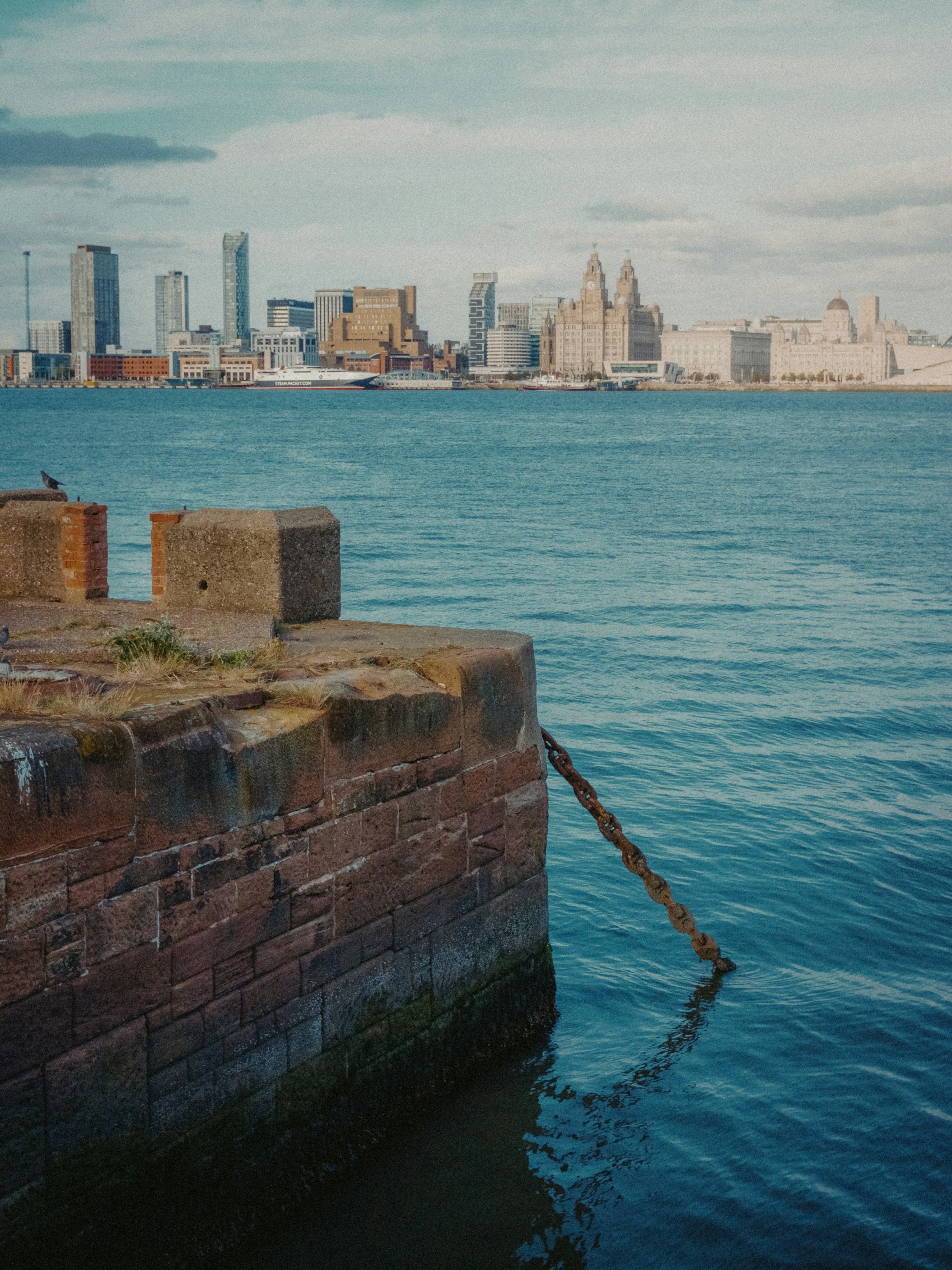 Harbor Edge: Red Brick Pier Reaching into Quiet Blue