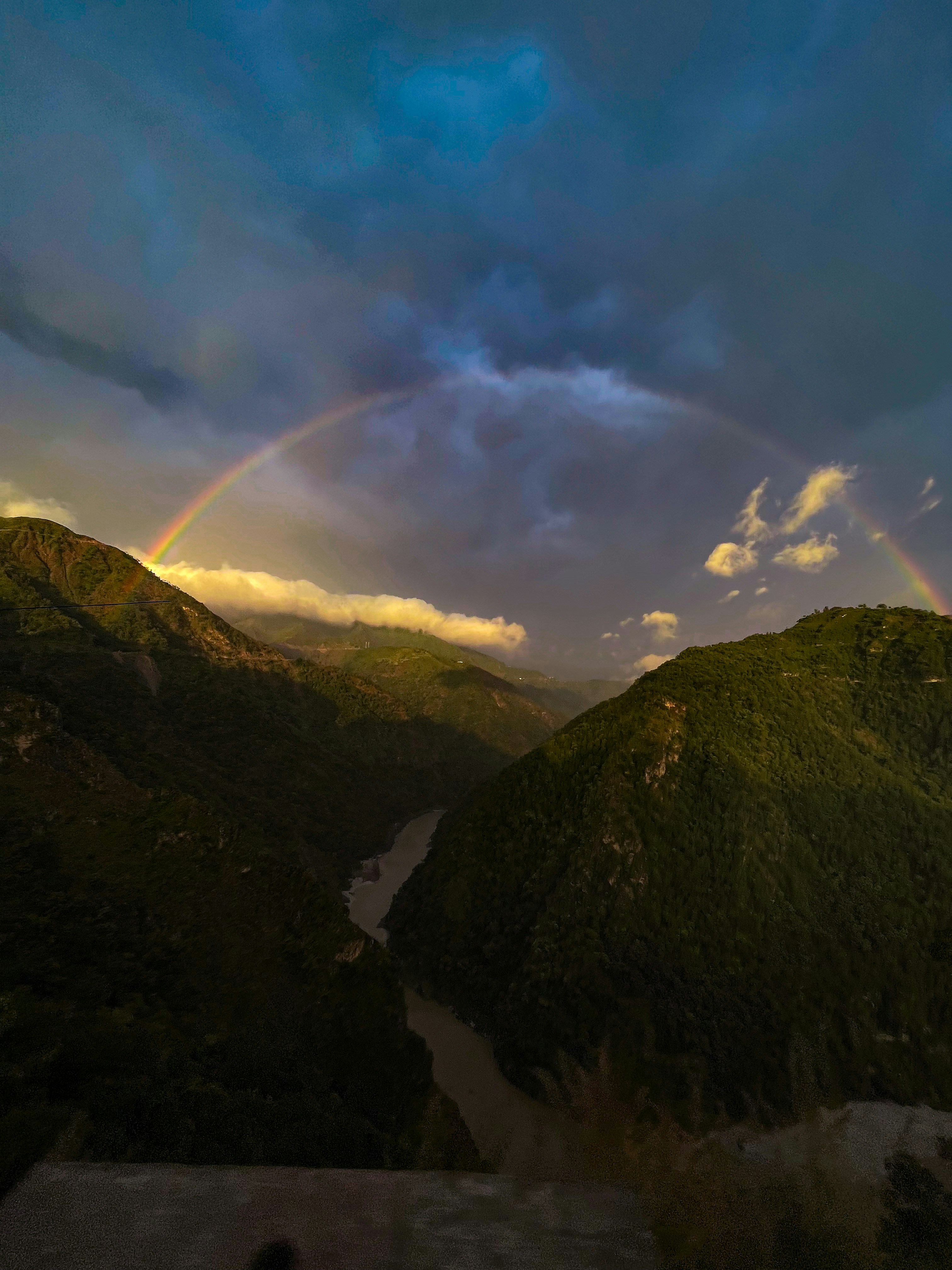 A rainbow in the sky over a valley photo – Free India Image on Unsplash