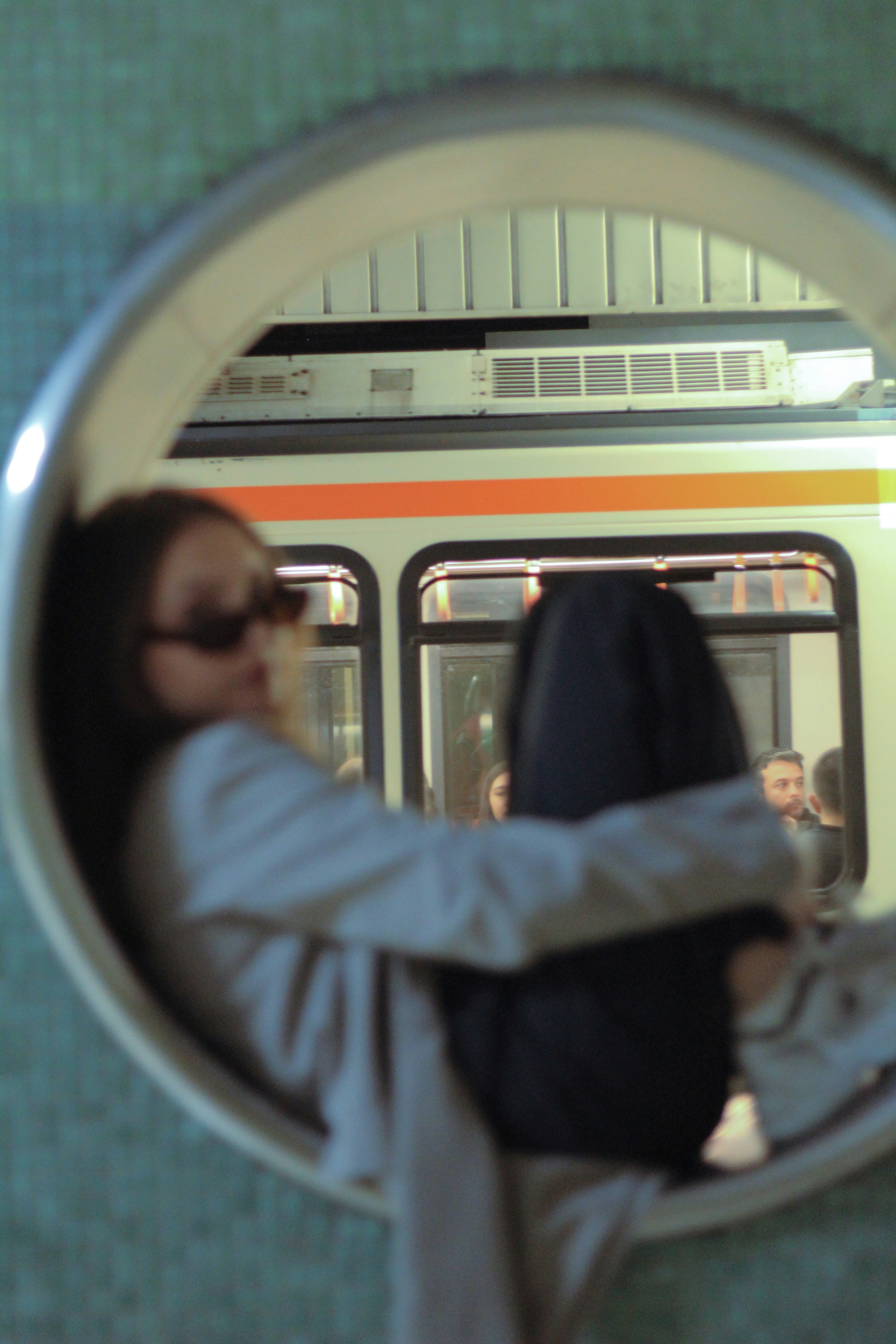 Circular Frame, Moving City: Reflections Inside a Subway Car