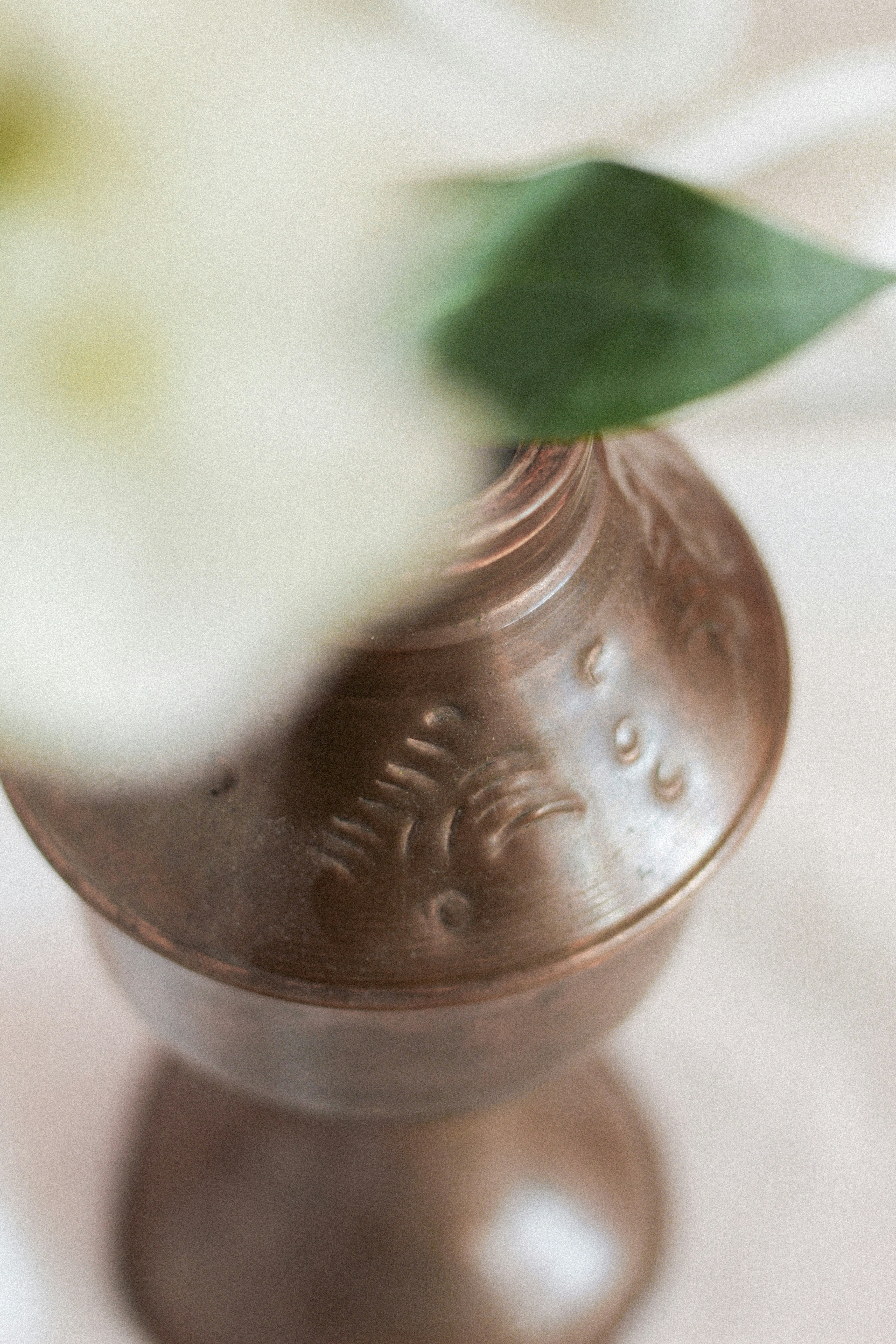 Copper Vessel in Soft Focus with Floral Foreground