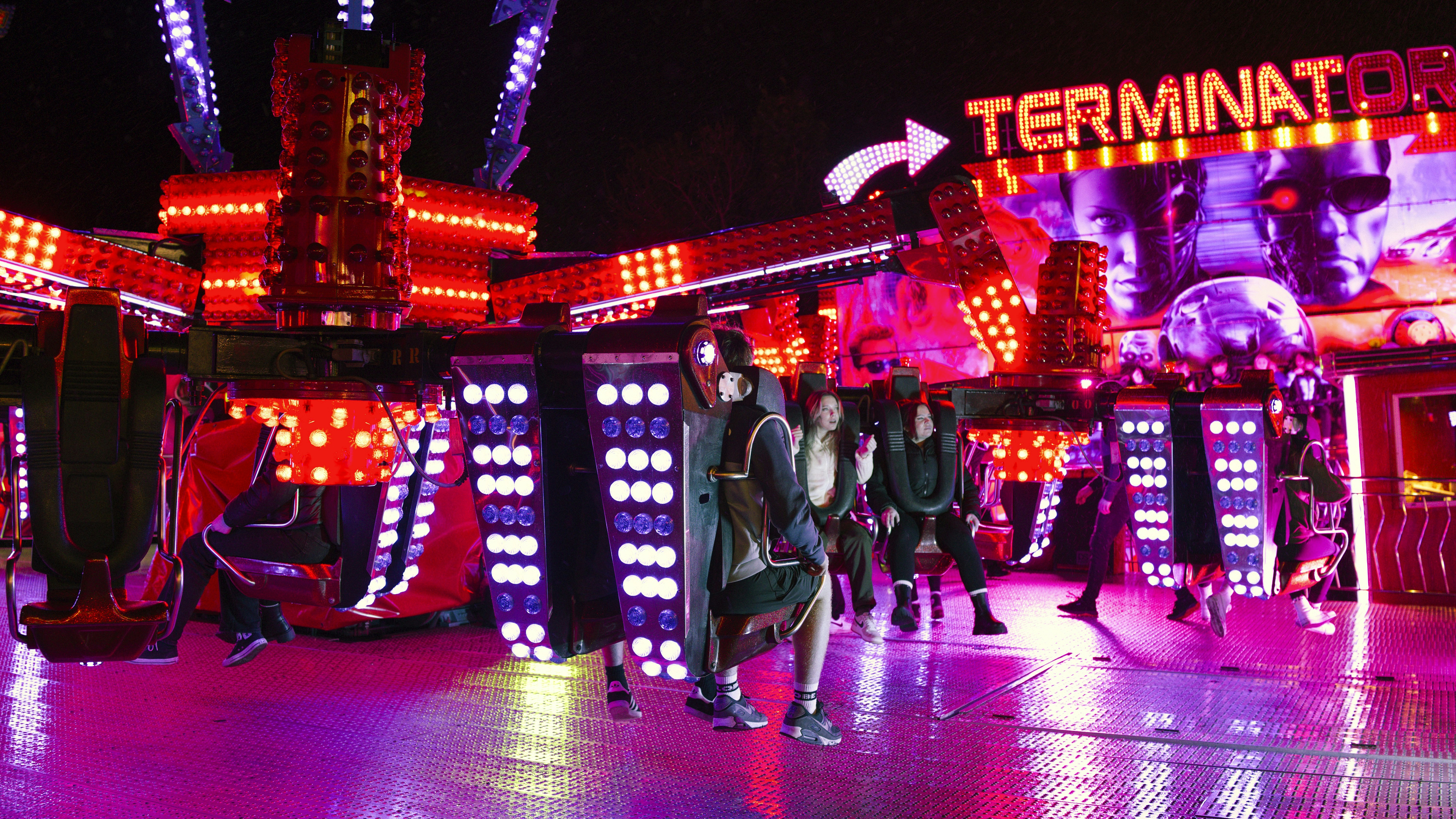 A group of people standing in front of a carnival ride photo – Free ...