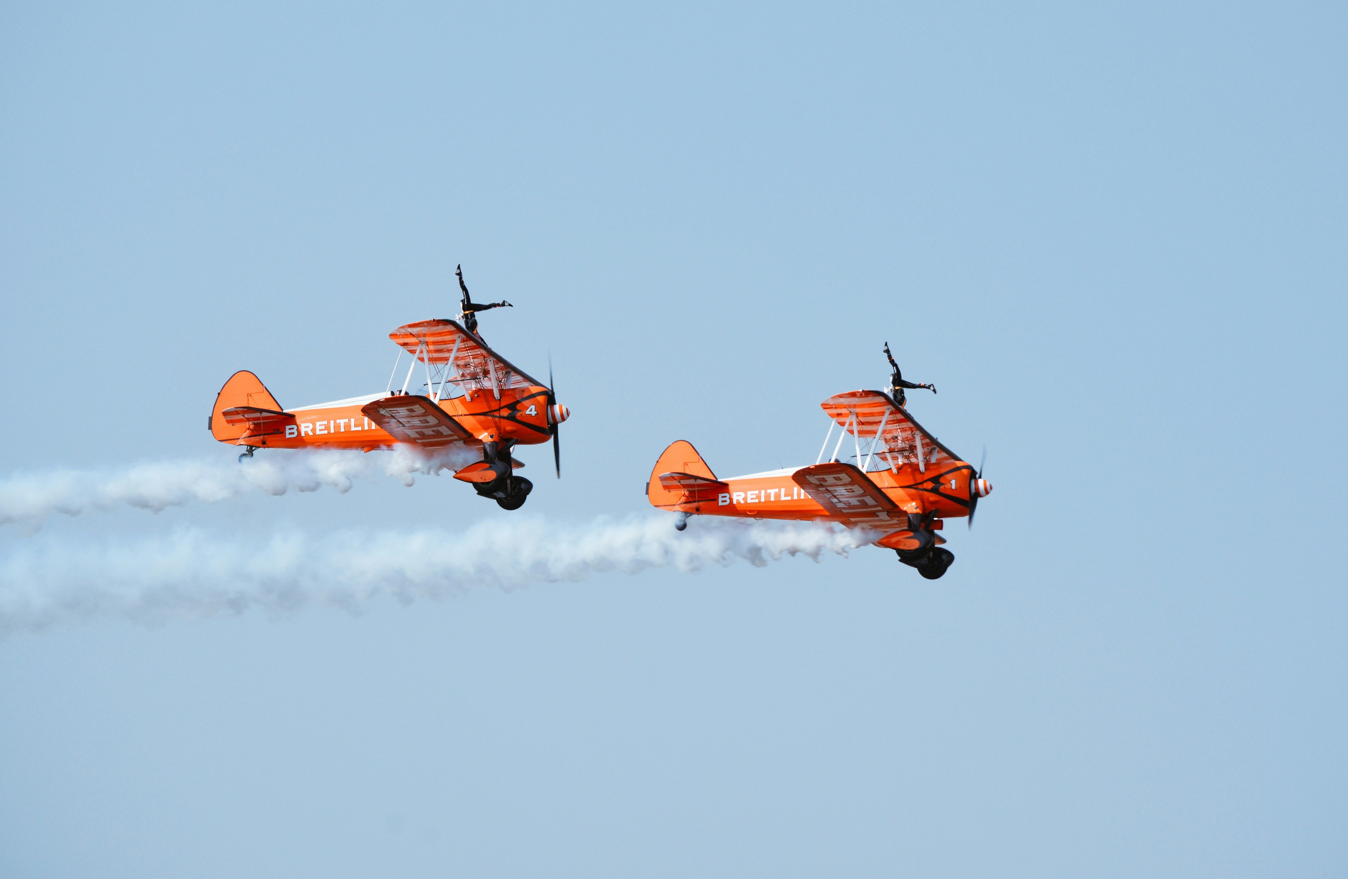 Two airplanes flying in the sky with smoke trailing behind them photo ...