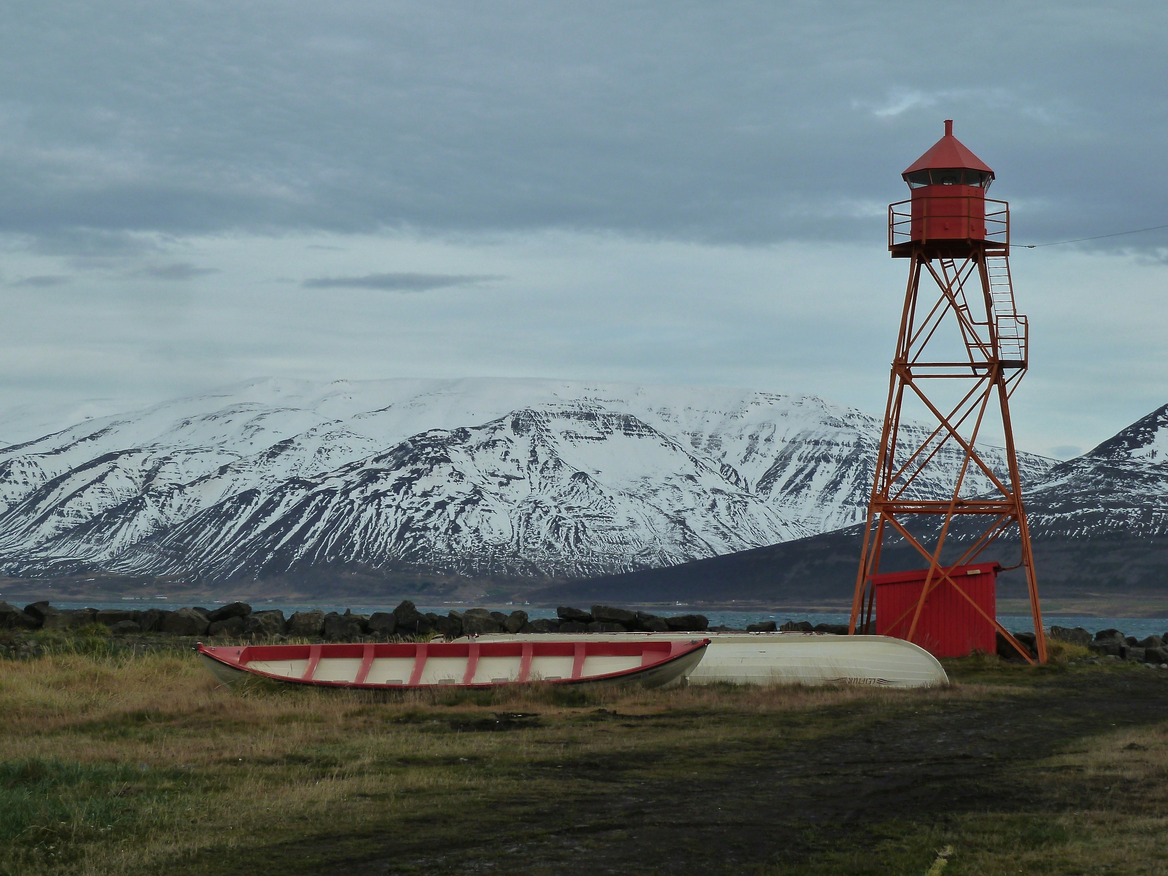 Crimson Watchtower Rising Over a Snow-Kissed Coastal Landscape