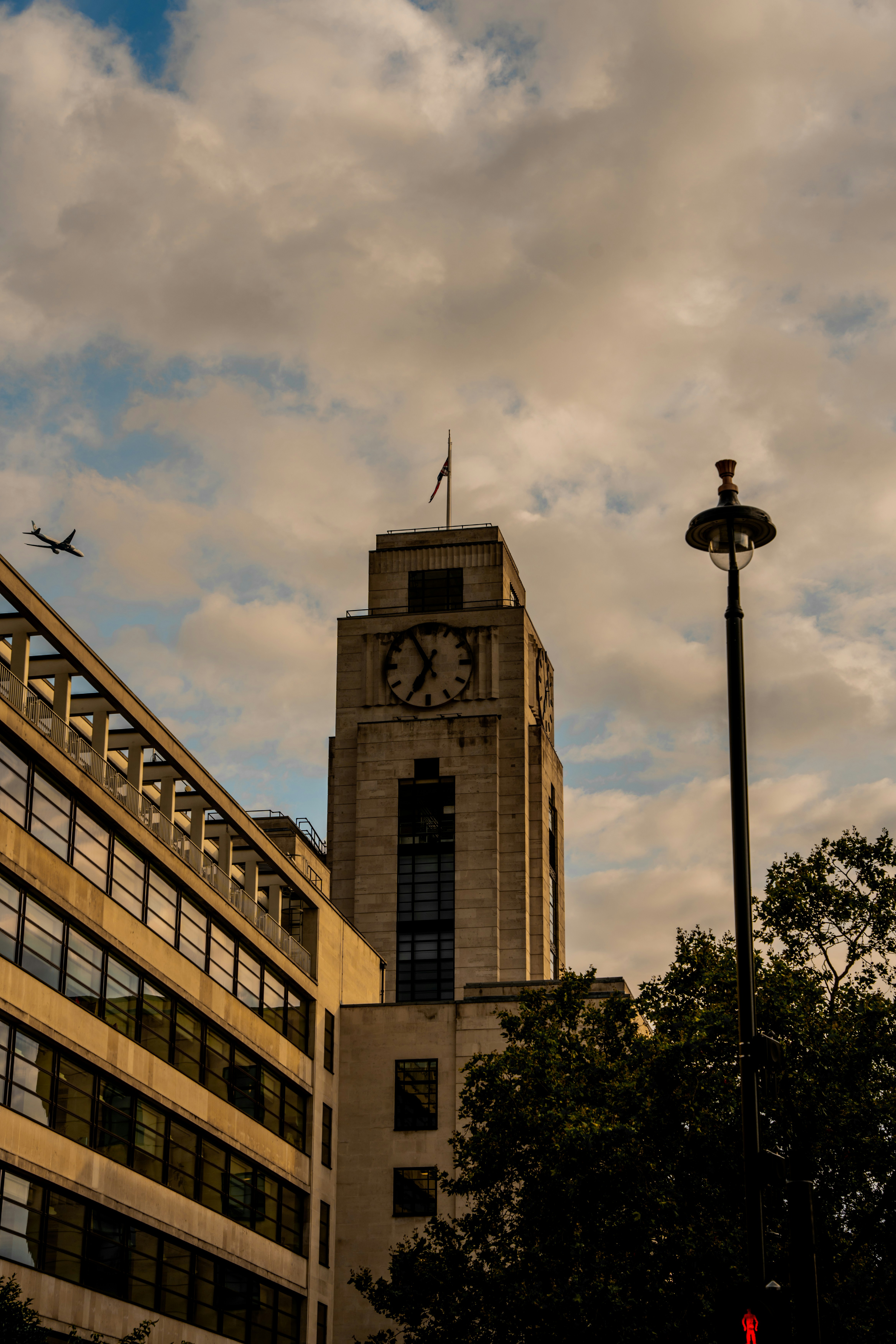 a tall clock tower sitting next to a tall building