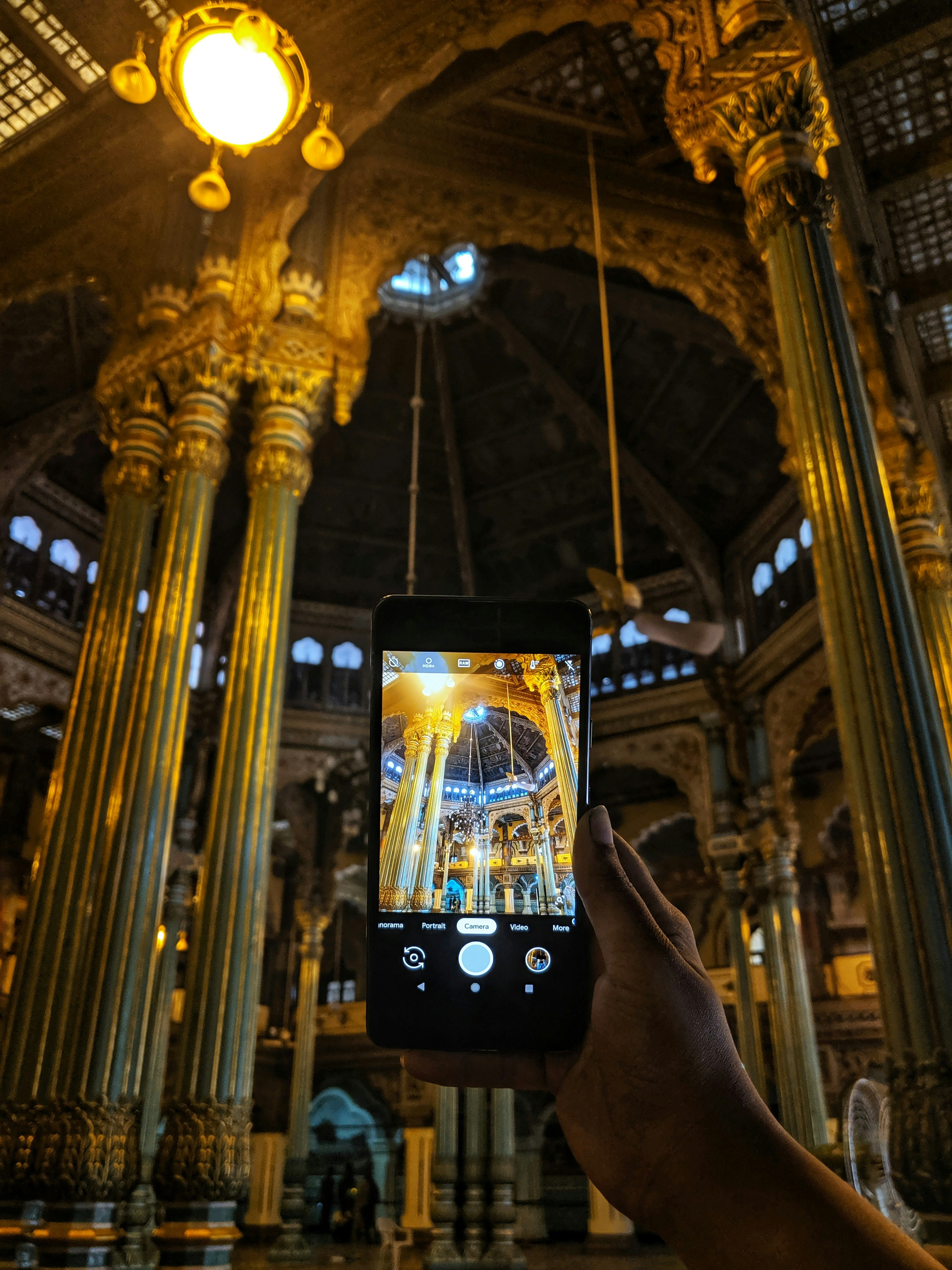 a person taking a picture of a building with a cell phone