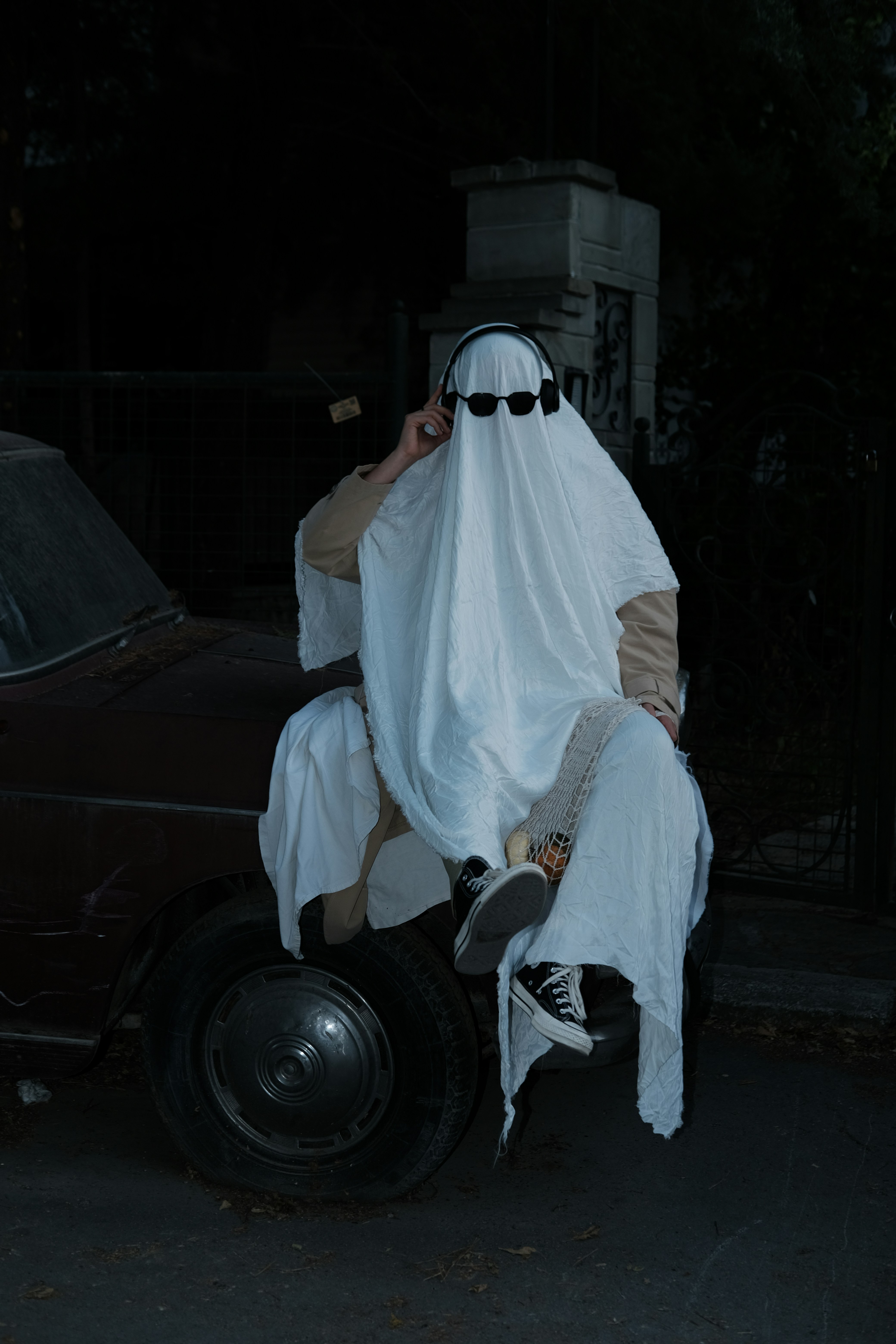 Night-Shift Ghost: Sunglasses-Clad Specter Perched on a Car