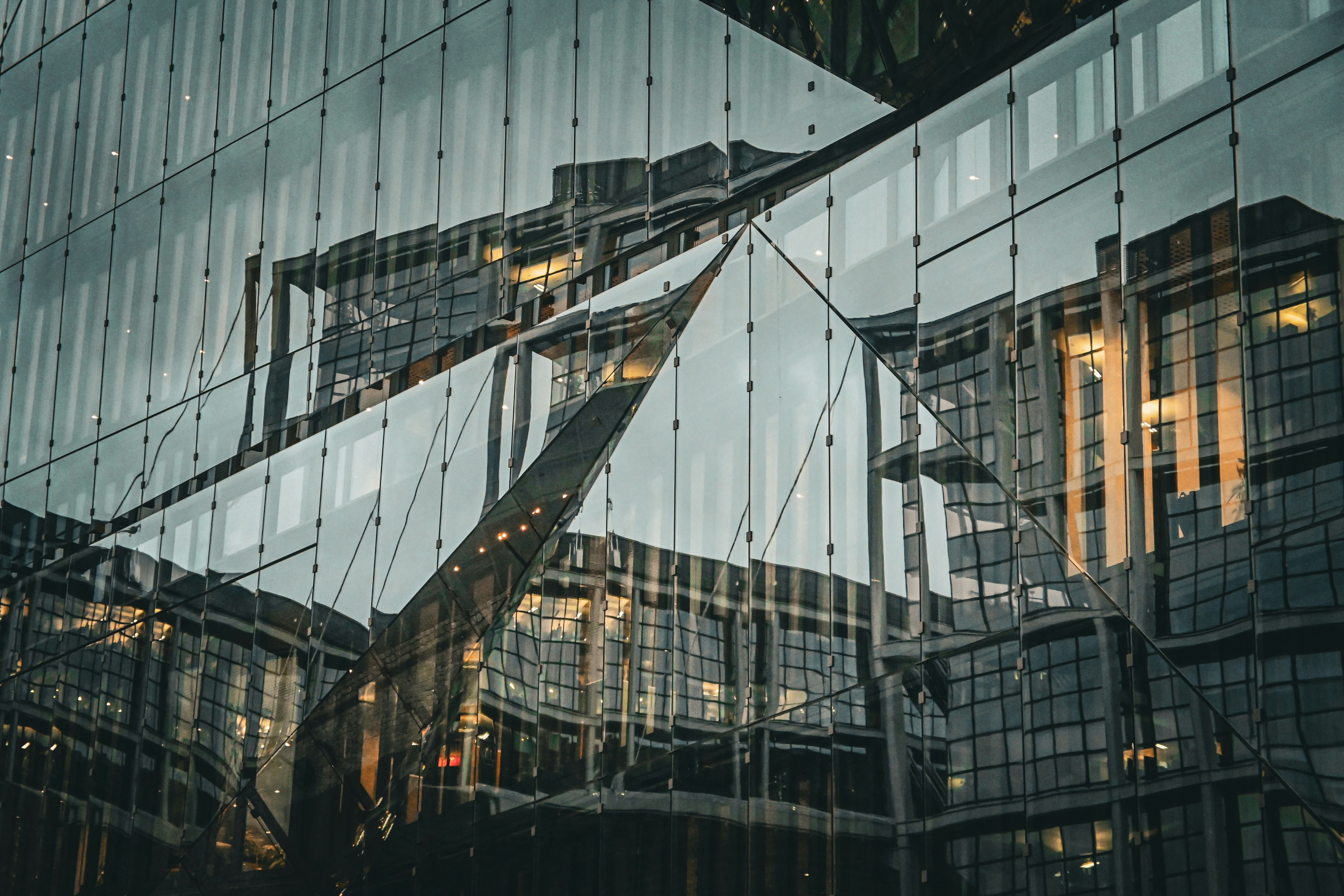 A reflection of a building in the glass of another building photo ...