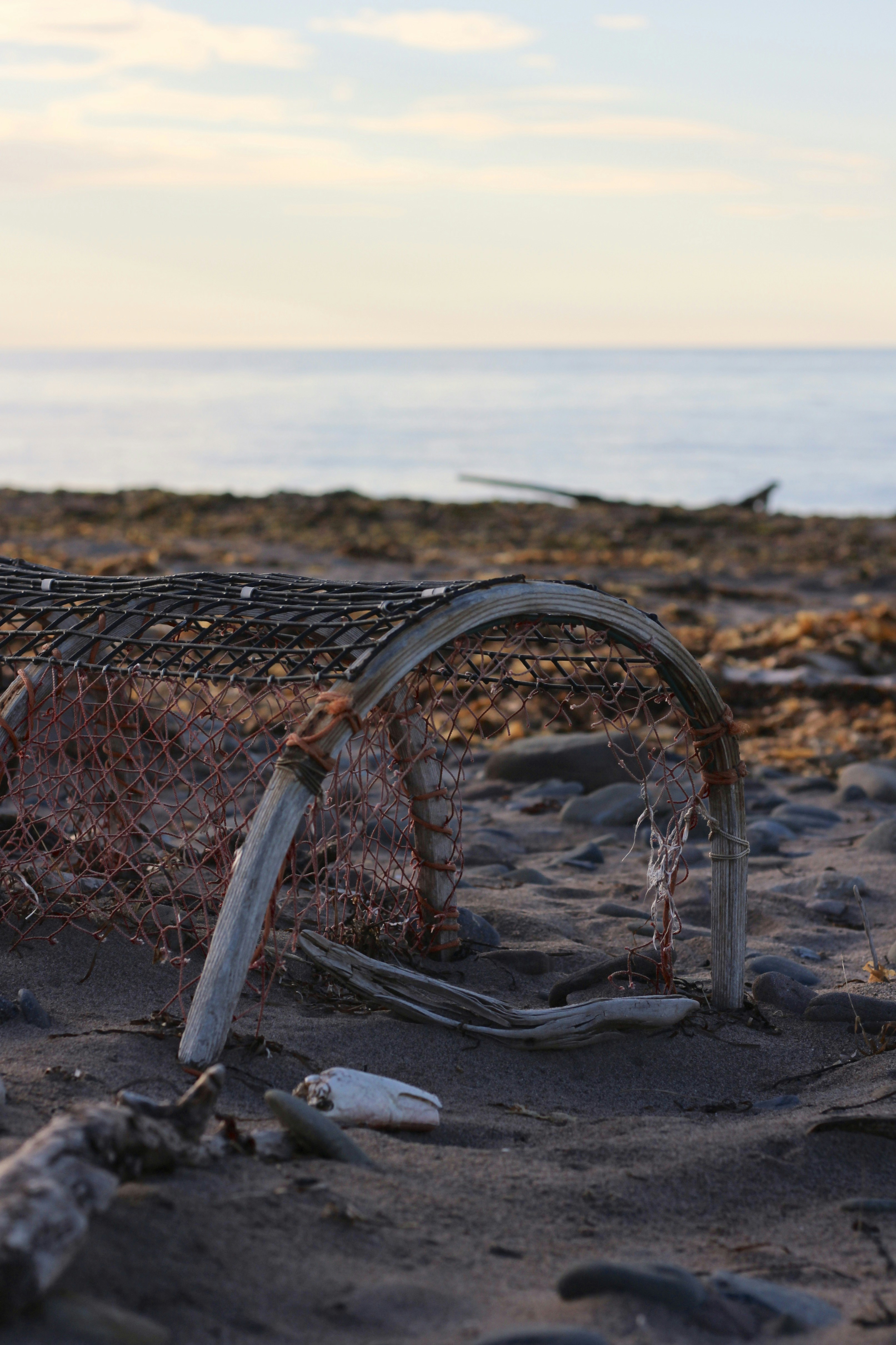 Rusted Hoop and Netting: A Quiet Beach Relic at Twilight