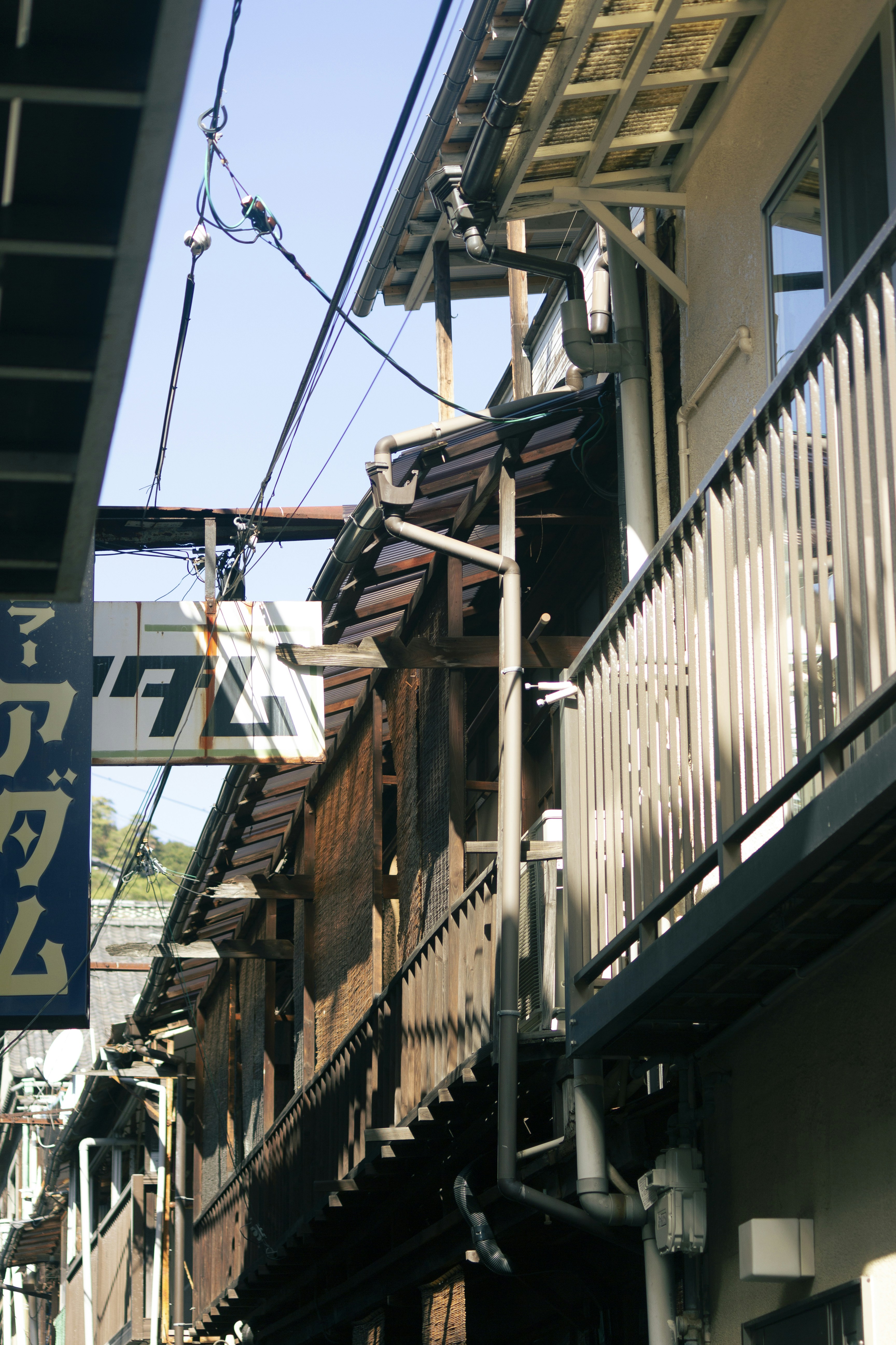 A street sign hanging from the side of a building photo – Free Japan ...