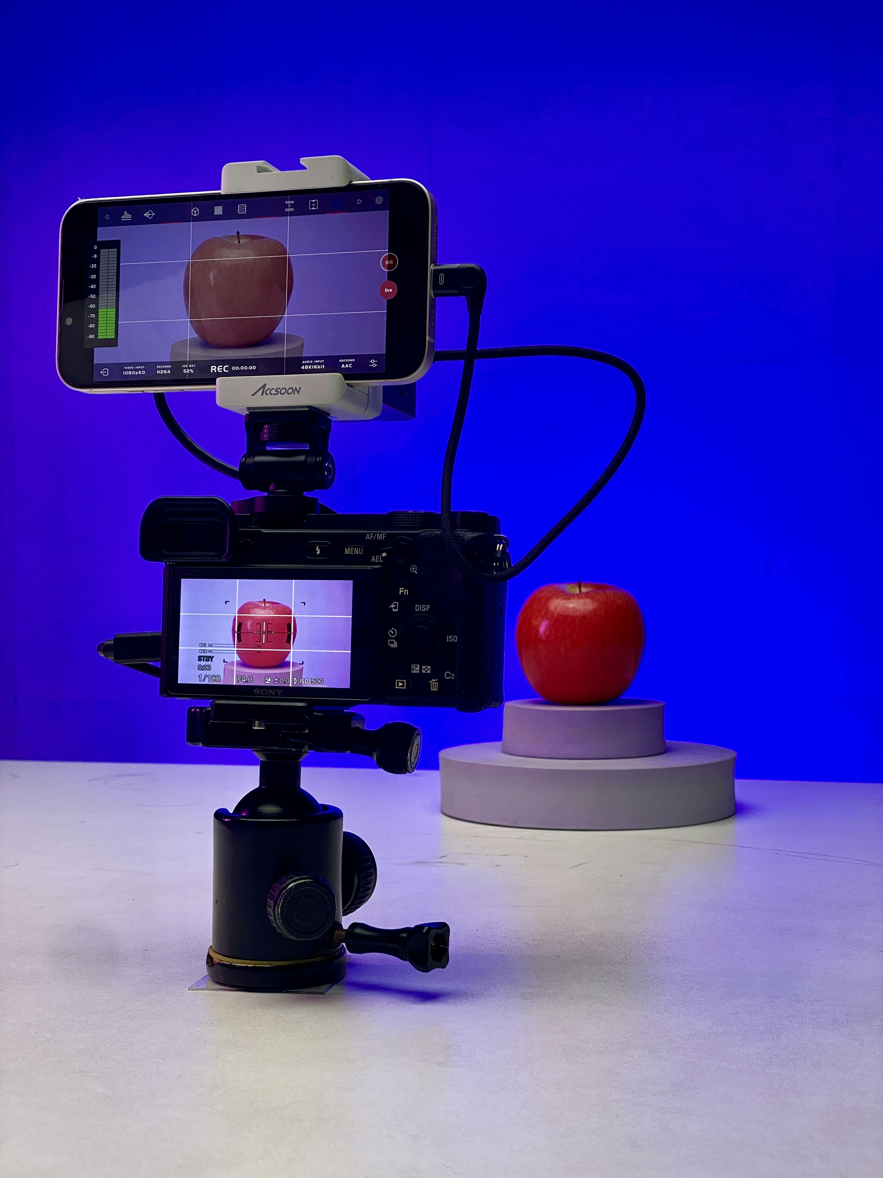 Blue Backdrop Apple Studio: A Camera Rig Captures a Red Apple