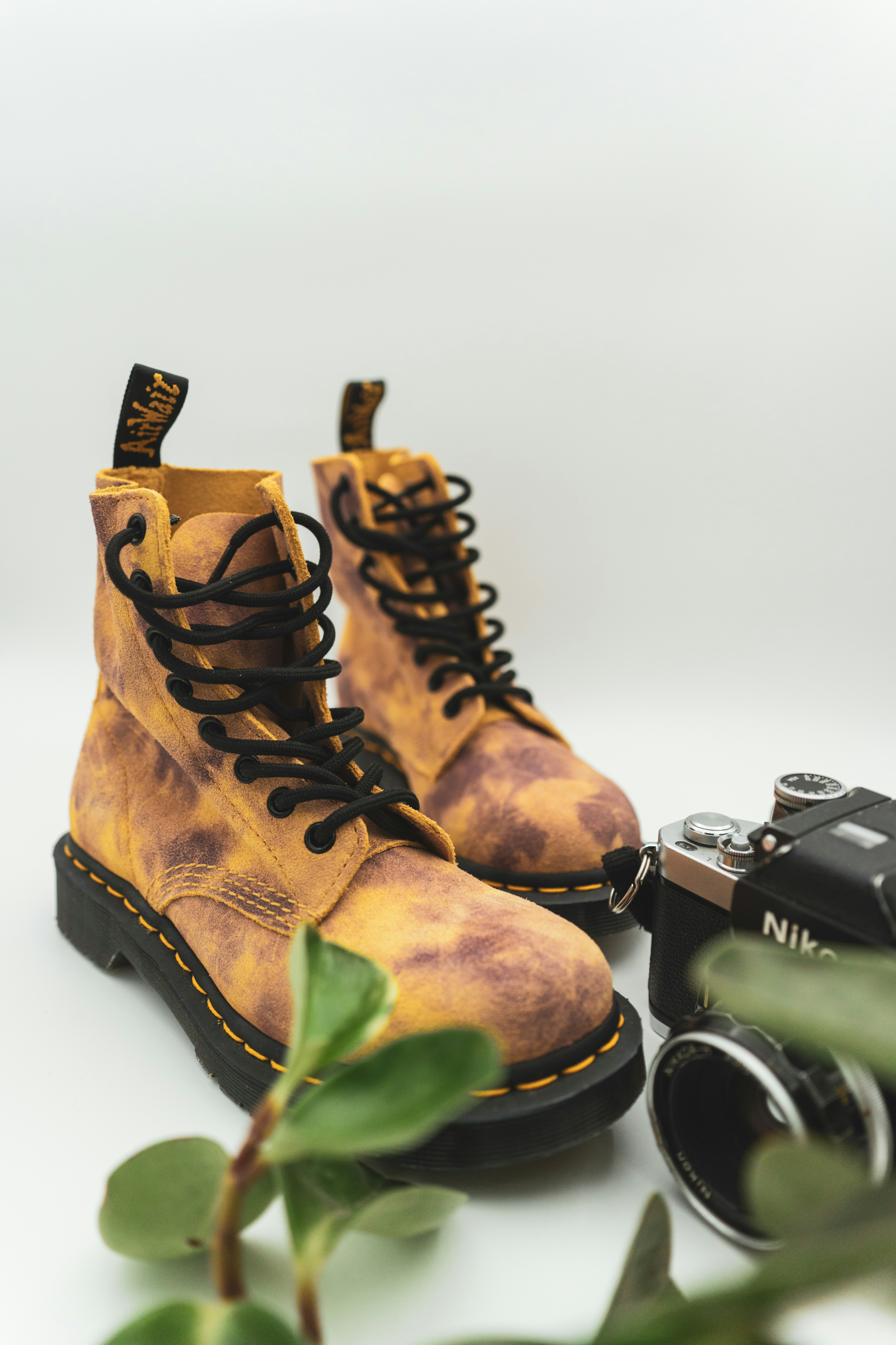 A pair of yellow boots sitting next to a camera photo – Free Brown ...