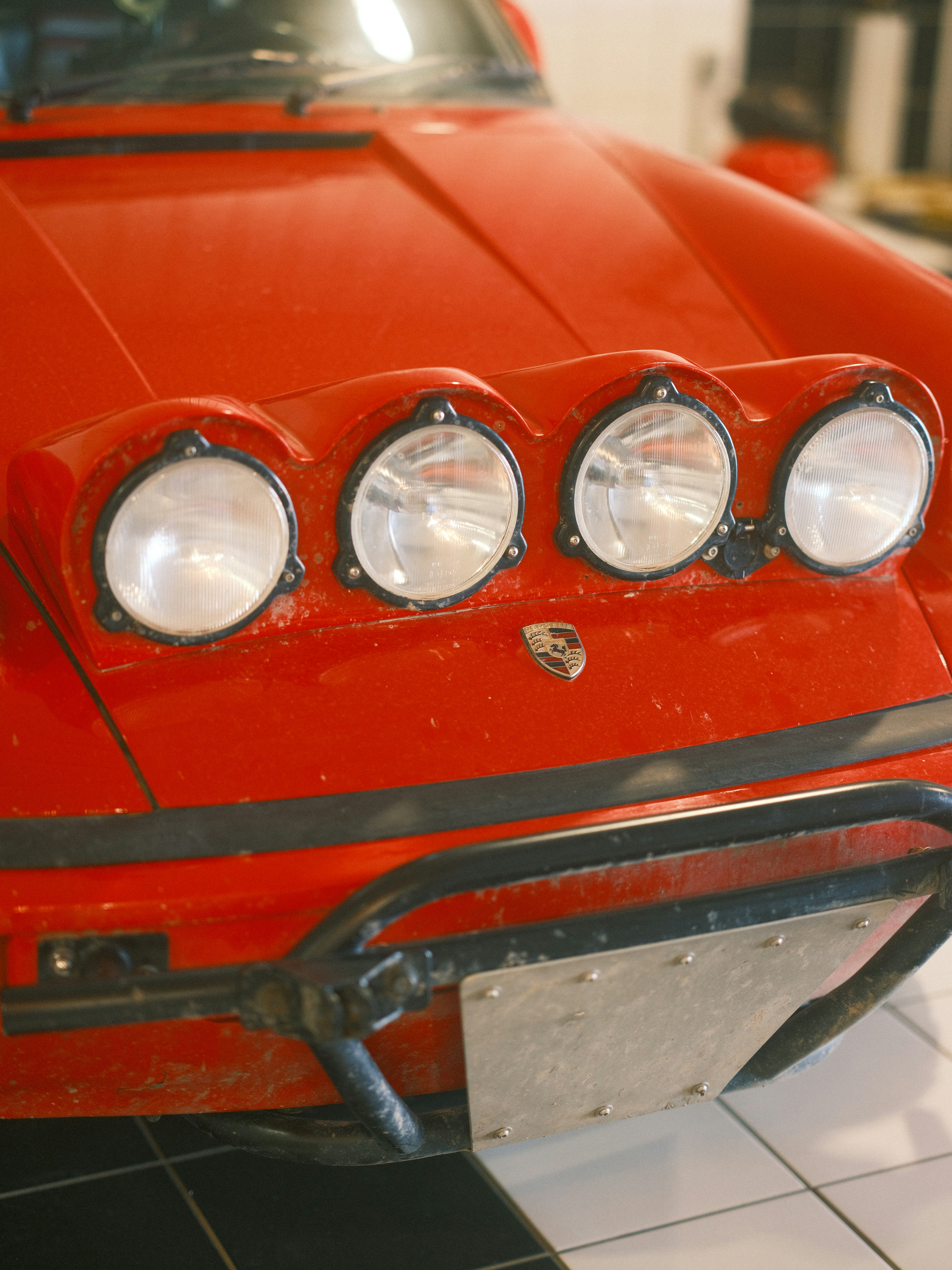 A close up of a red car on a tiled floor photo – Free Car Image on Unsplash