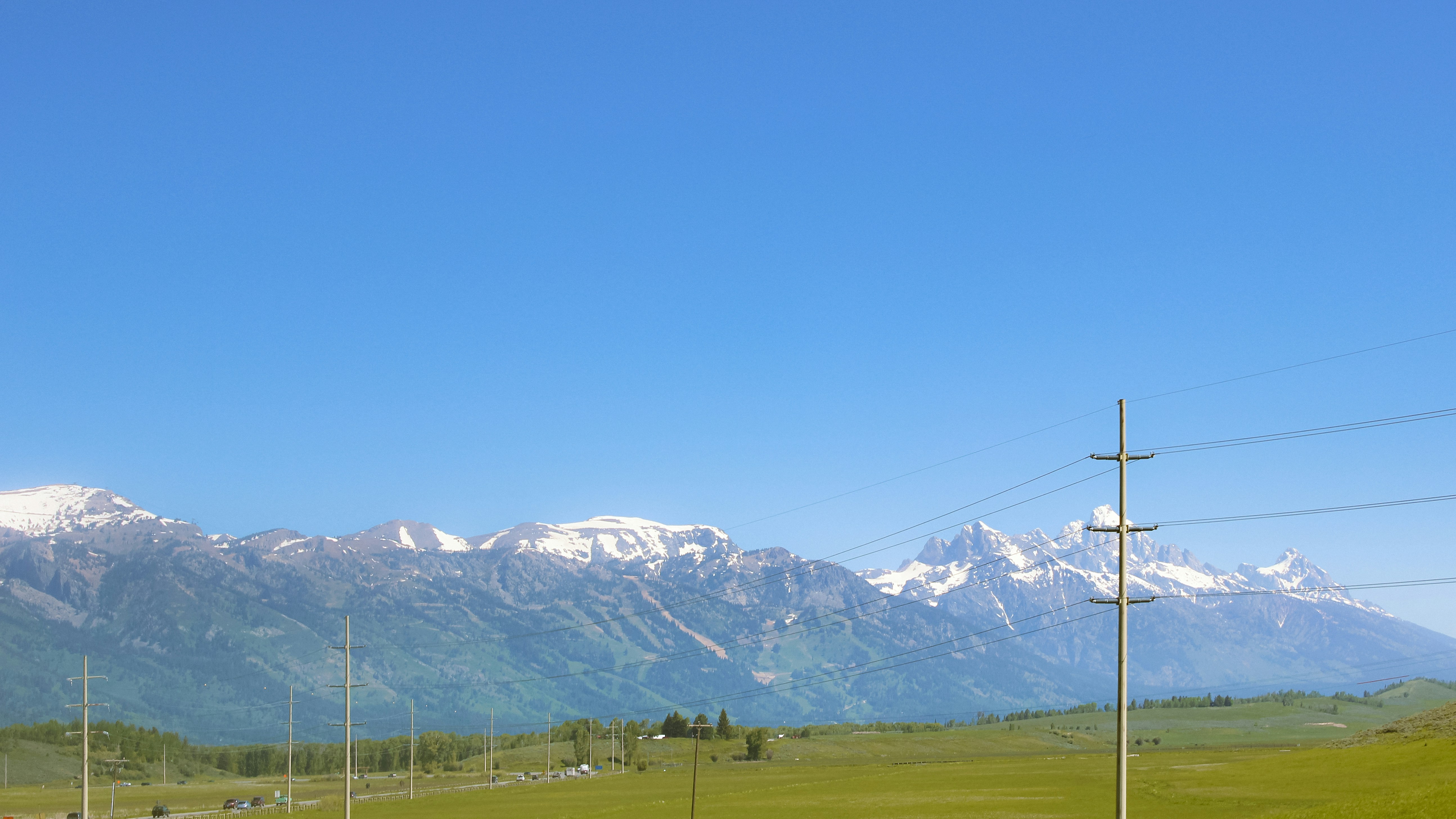 Cerulean Sky Over Snow-Dusted Peaks: Prairie Under a Wireline Horizon