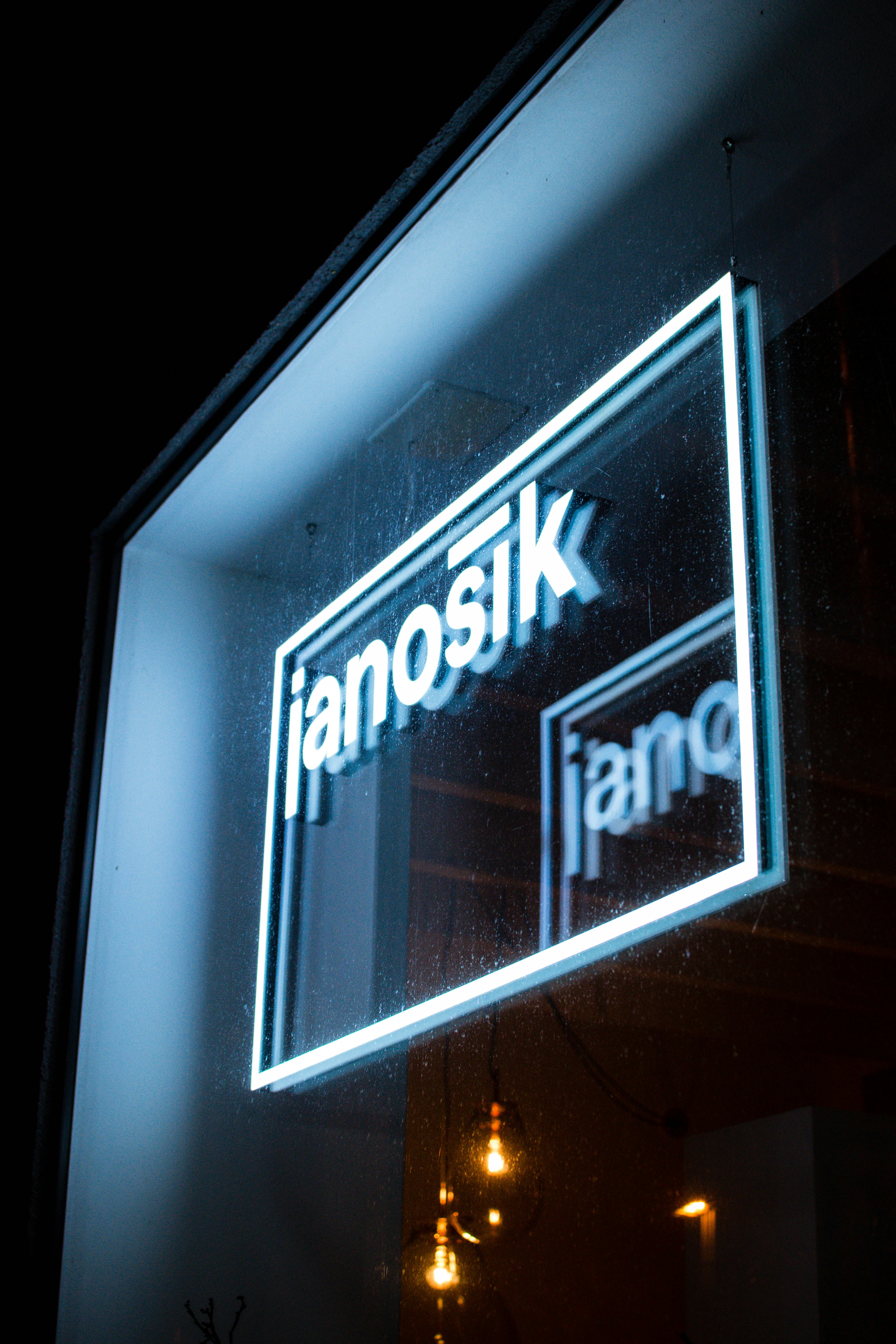 Blue Neon Frame Reflections in a Night Window