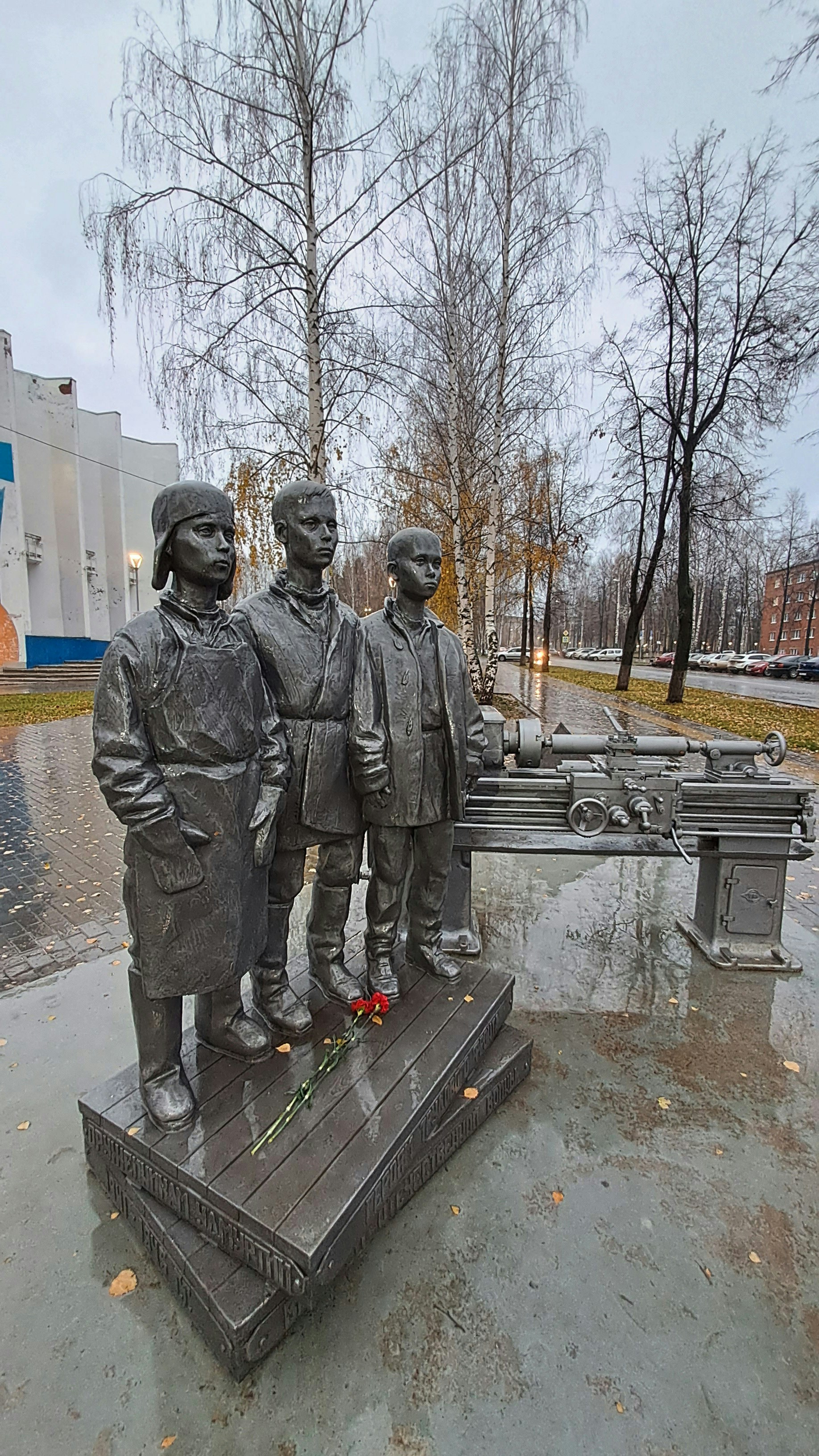 The monument to “Gunsmiths of Udmurtia, Heroes of the Labor Front of the Great Patriotic War” is a sculptural composition opened in 2019 in Izhevsk, dedicated to teenagers who worked at the factories of Udmurtia during the Great Patriotic War. Author - Izhevsk sculptor Pavel Medvedev | a statue of three people standing next to a bench