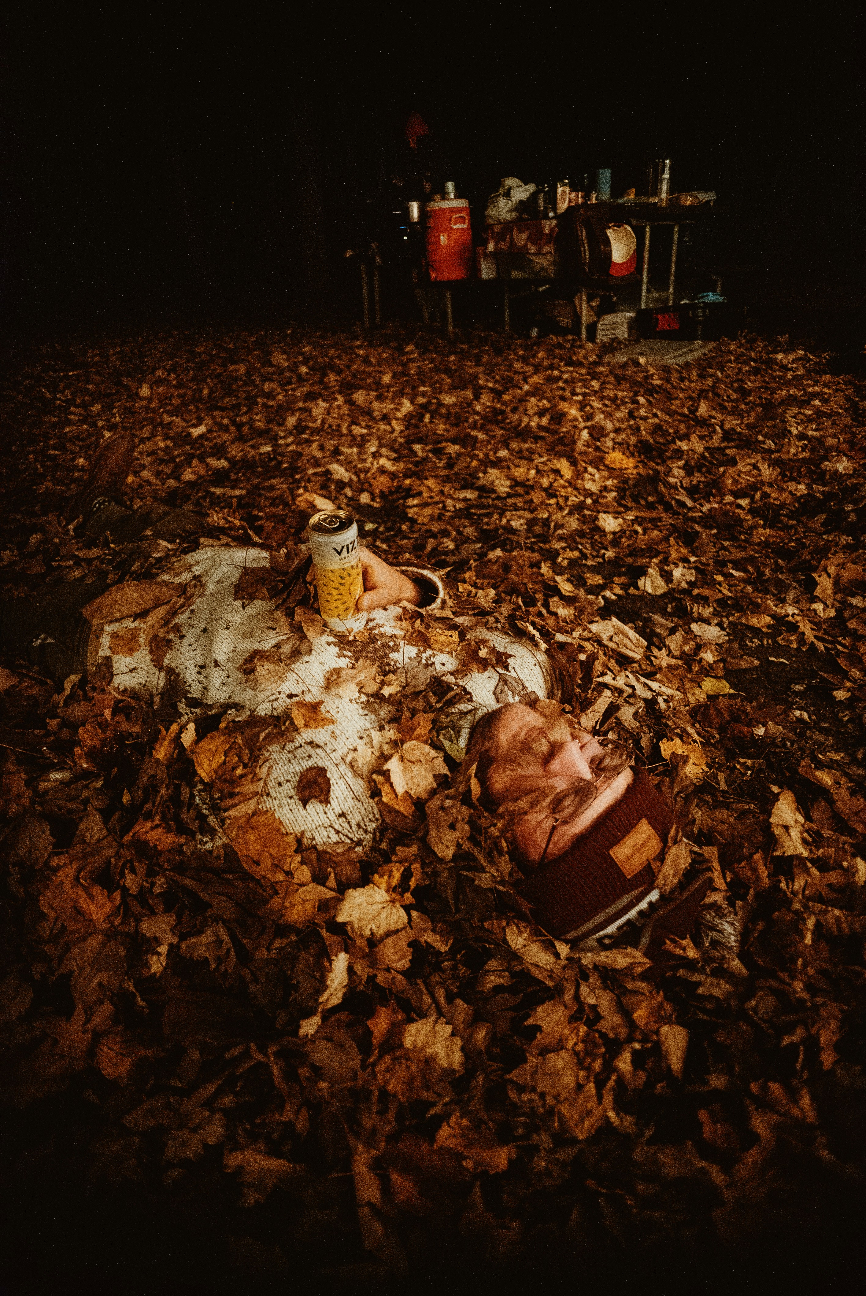 Nightfall in the Leaf-bed: A Campfire Rest Amid Autumn Debris