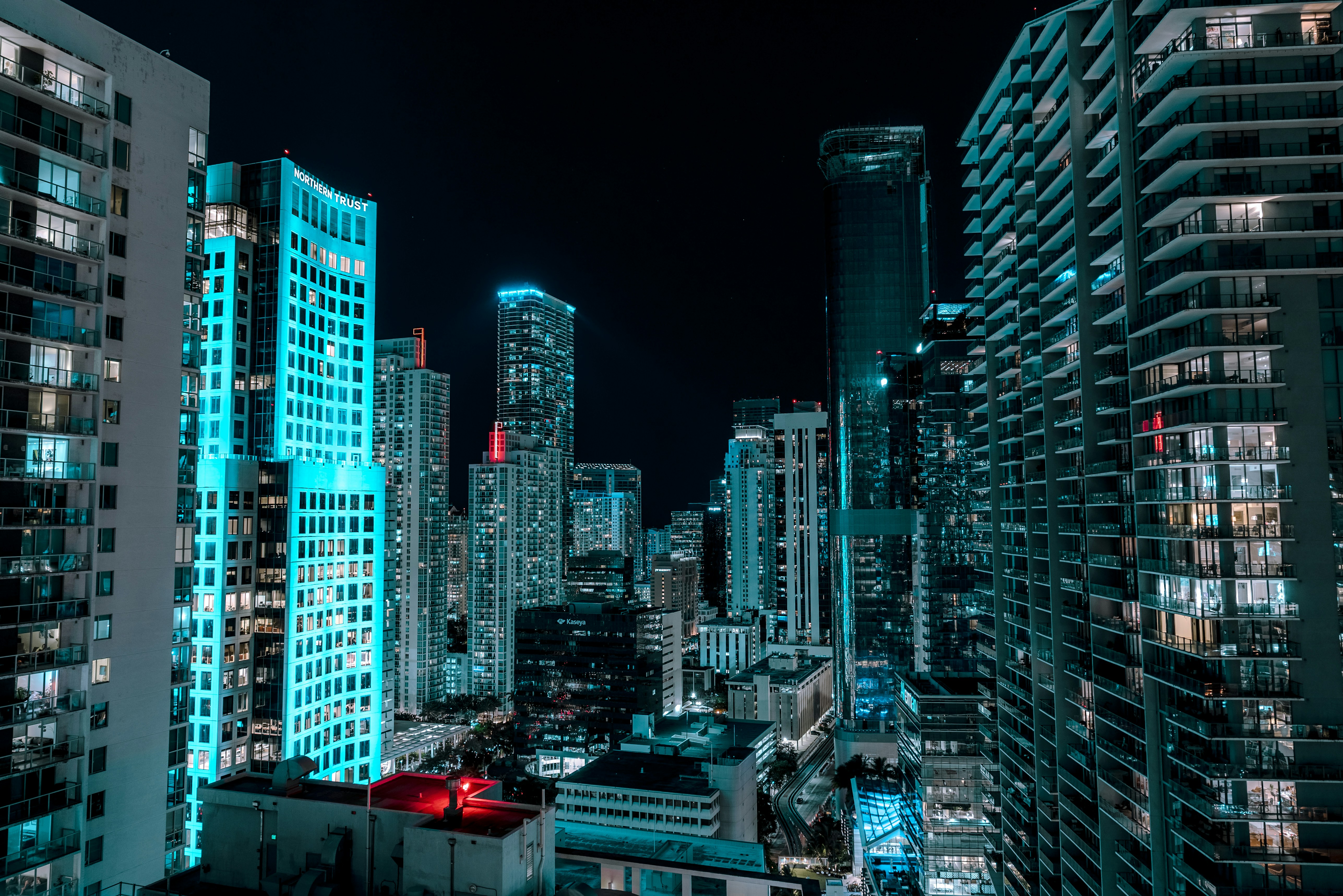 A view of a city at night from the top of a building photo – Free City ...