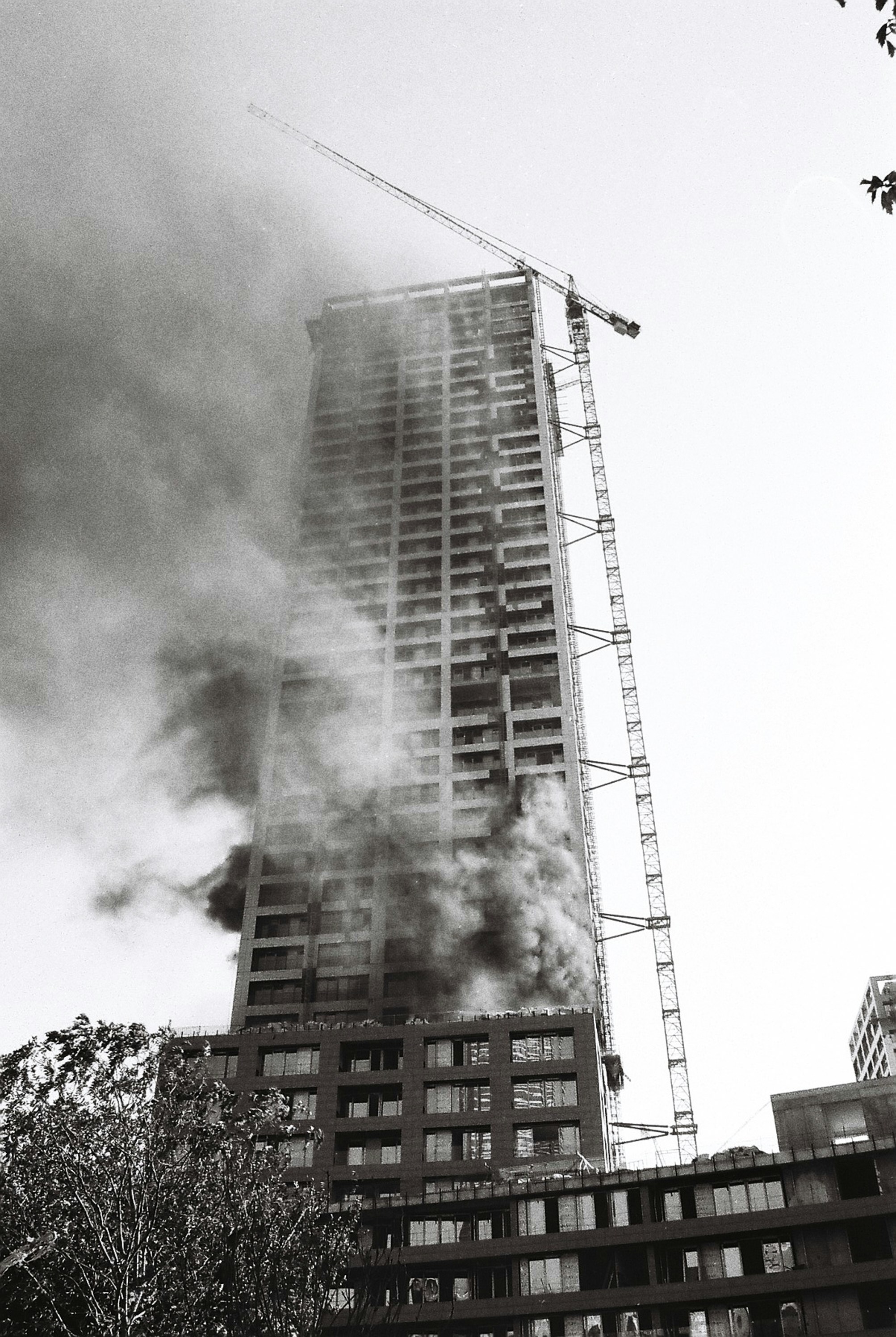 Smoke over Steel: A Monochrome Tower Under Construction