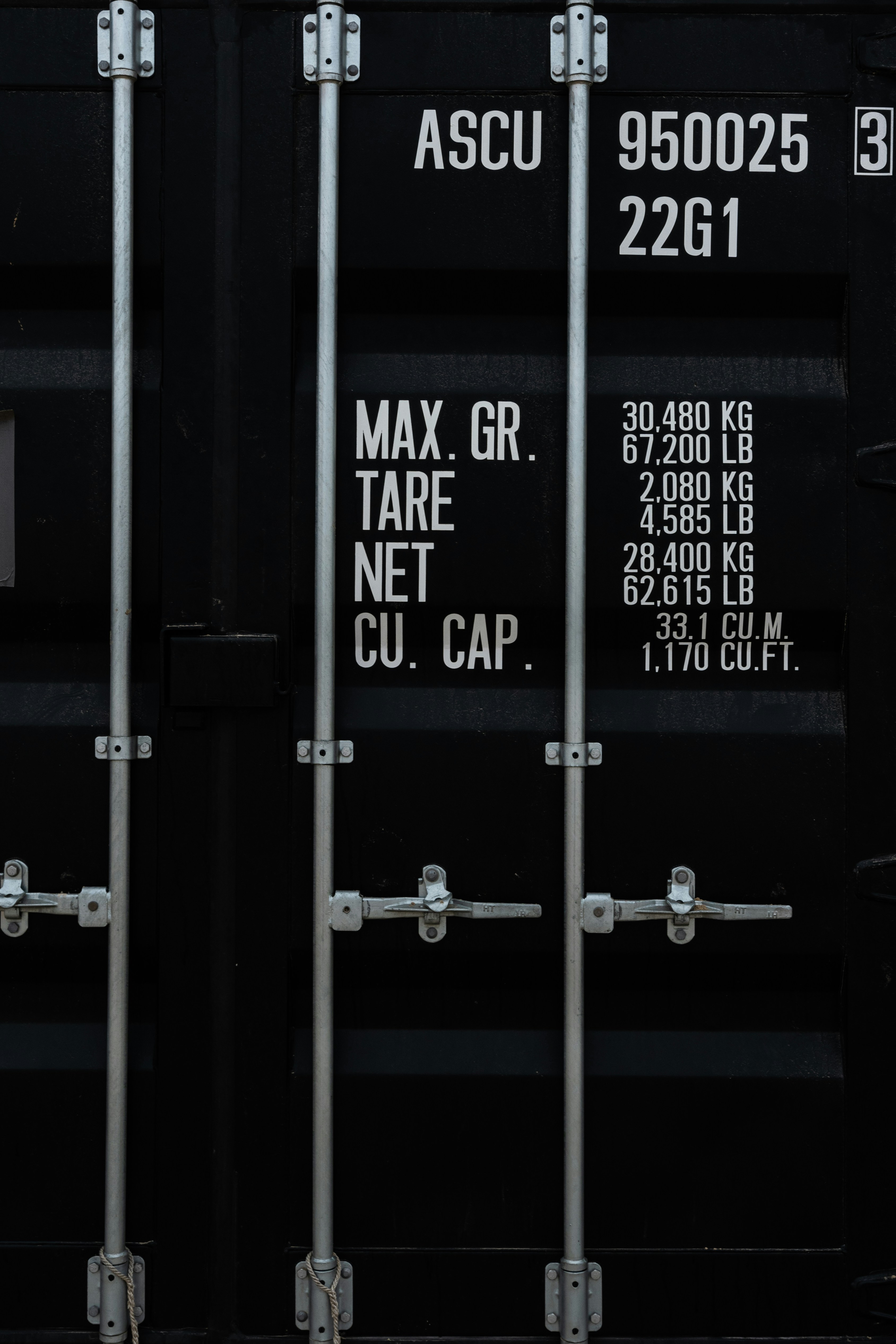 Monochrome Freight Glyphs: Steel Bars Framing a Cargo Door
