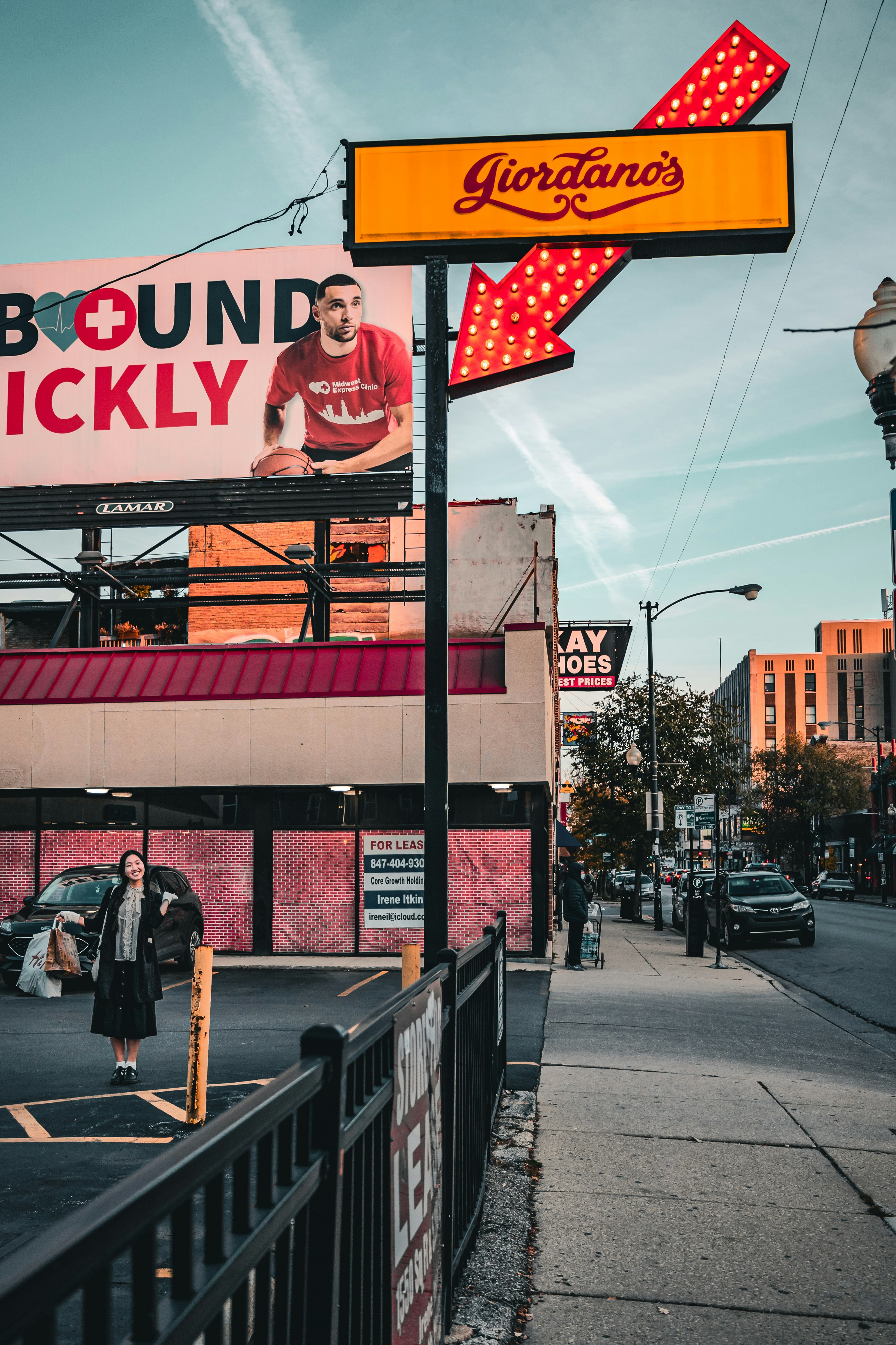 Neon Arrow and Urban Tapestry on a Sunlit LA Street