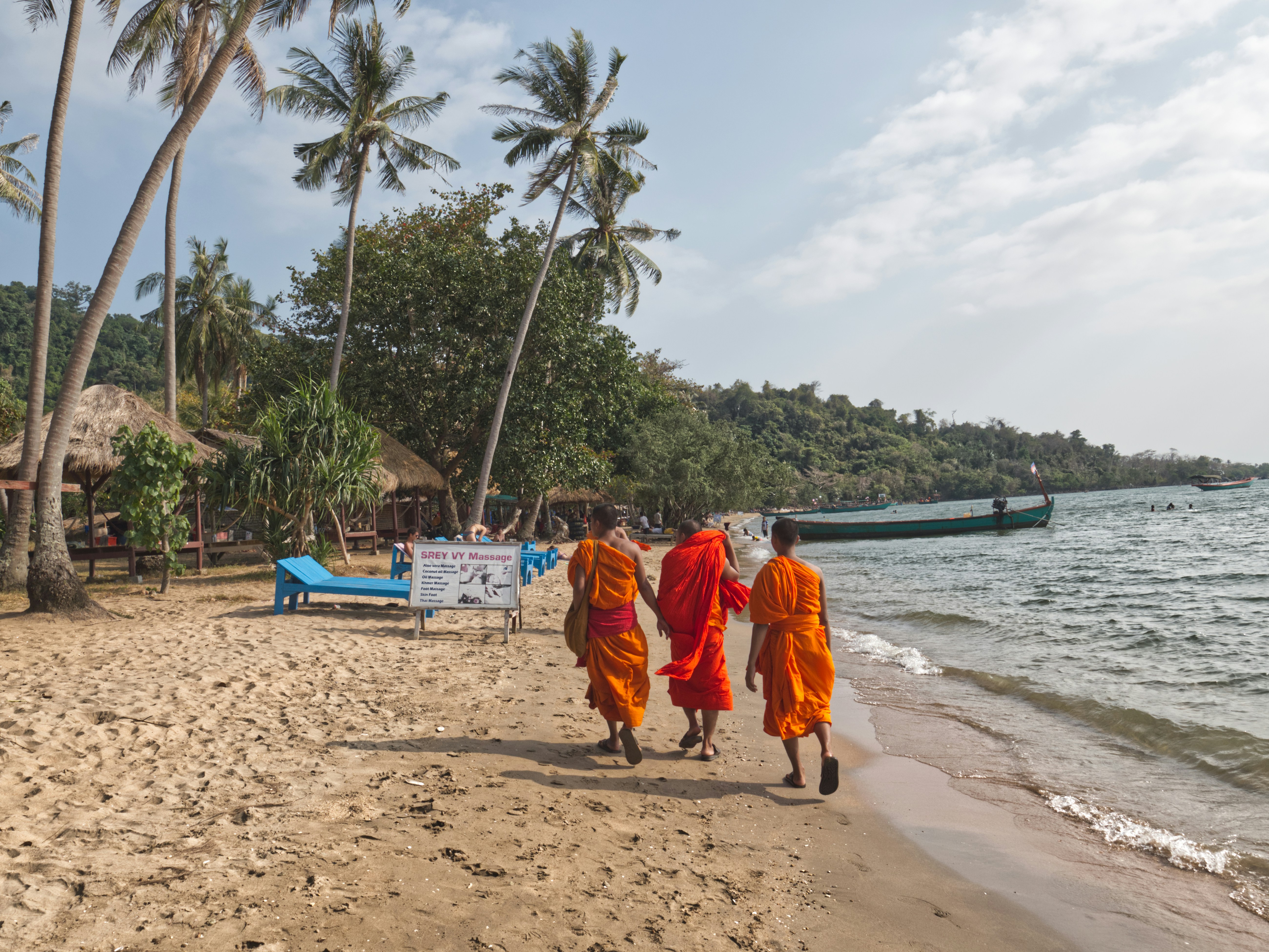 Three Monks on a Sunlit Beach: Palm Fronds, Orange Robes, and Quiet Sea