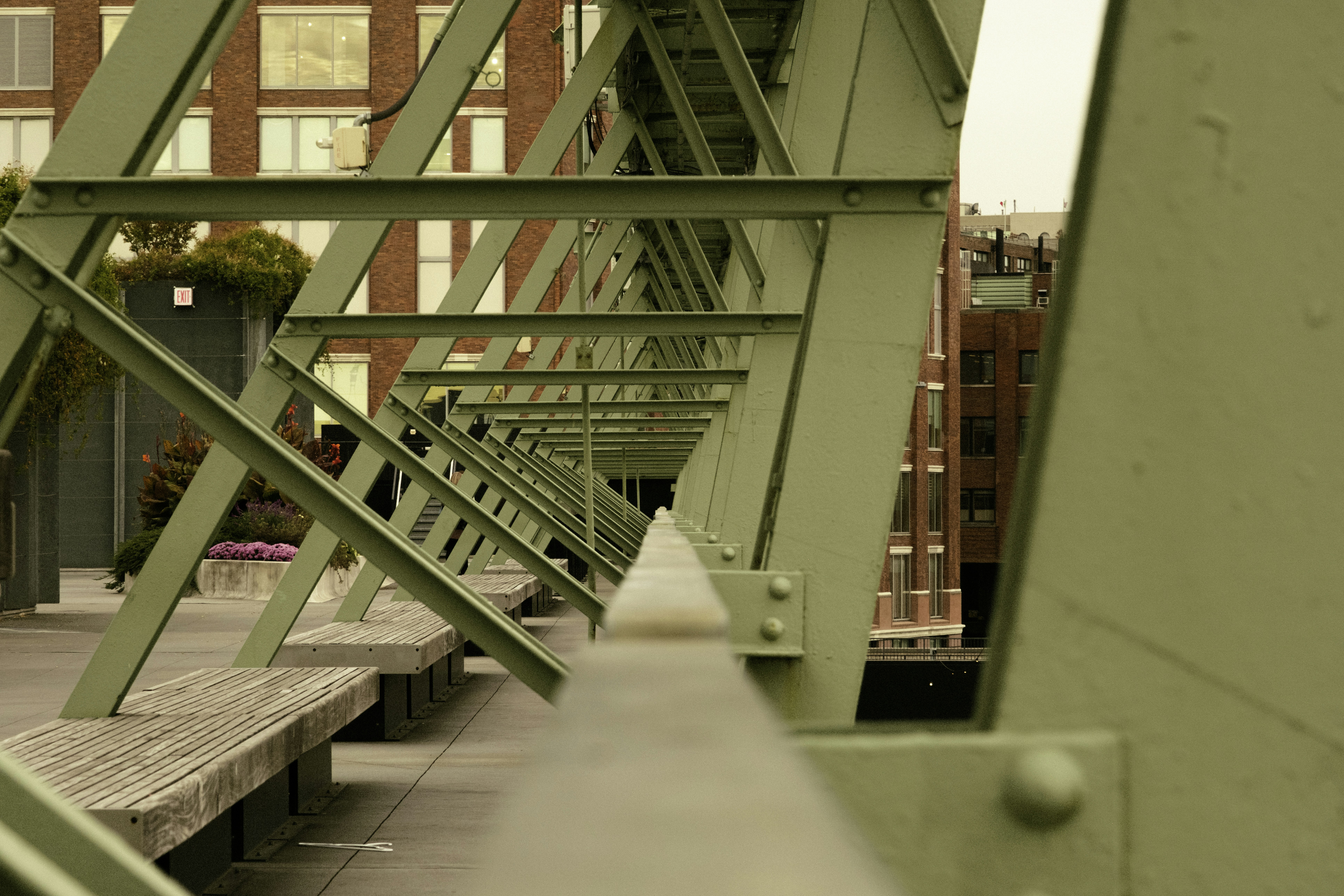 A green metal bridge with benches on the side photo – Free City Image ...