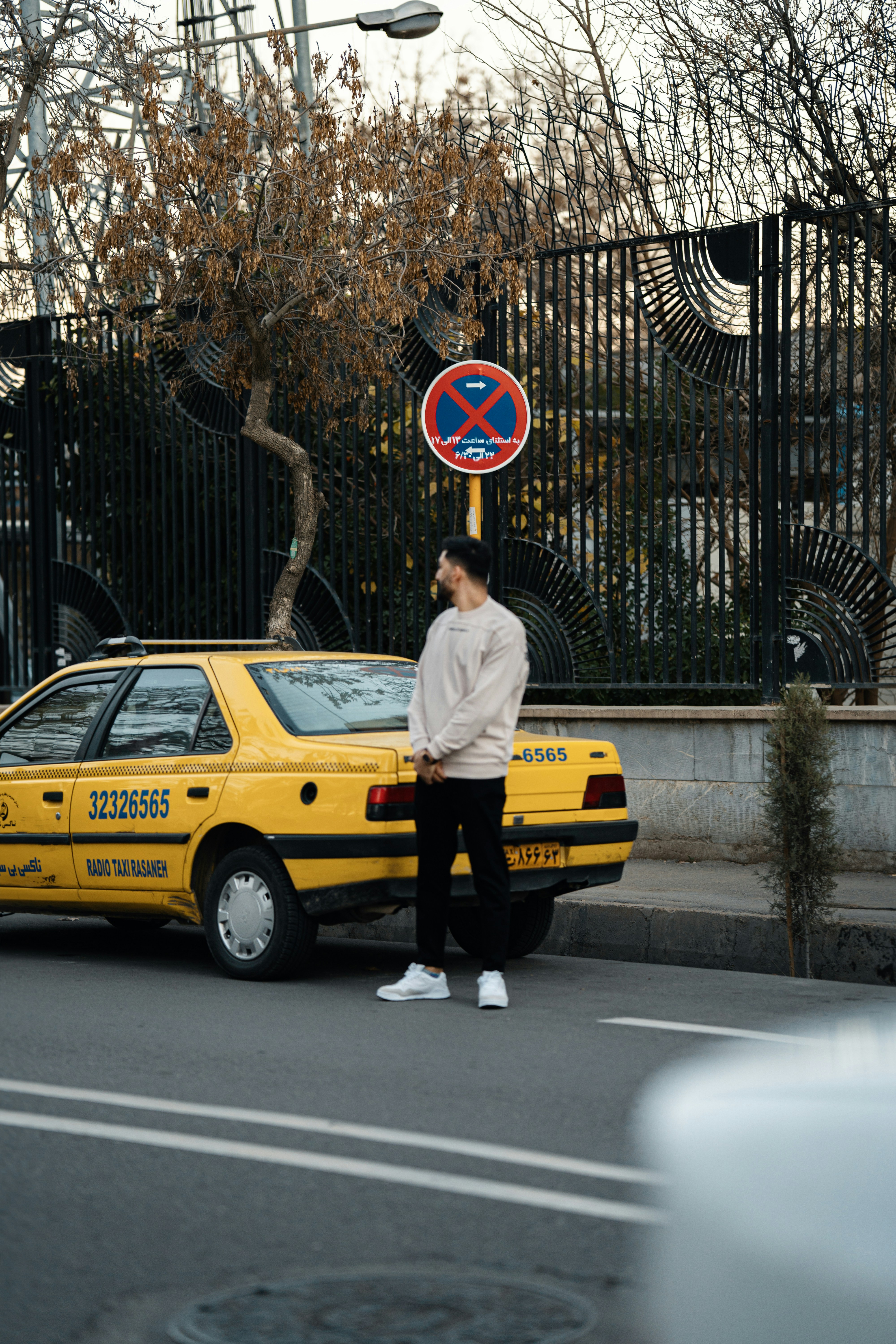 A man standing in front of a yellow taxi photo – Free Model Image on ...