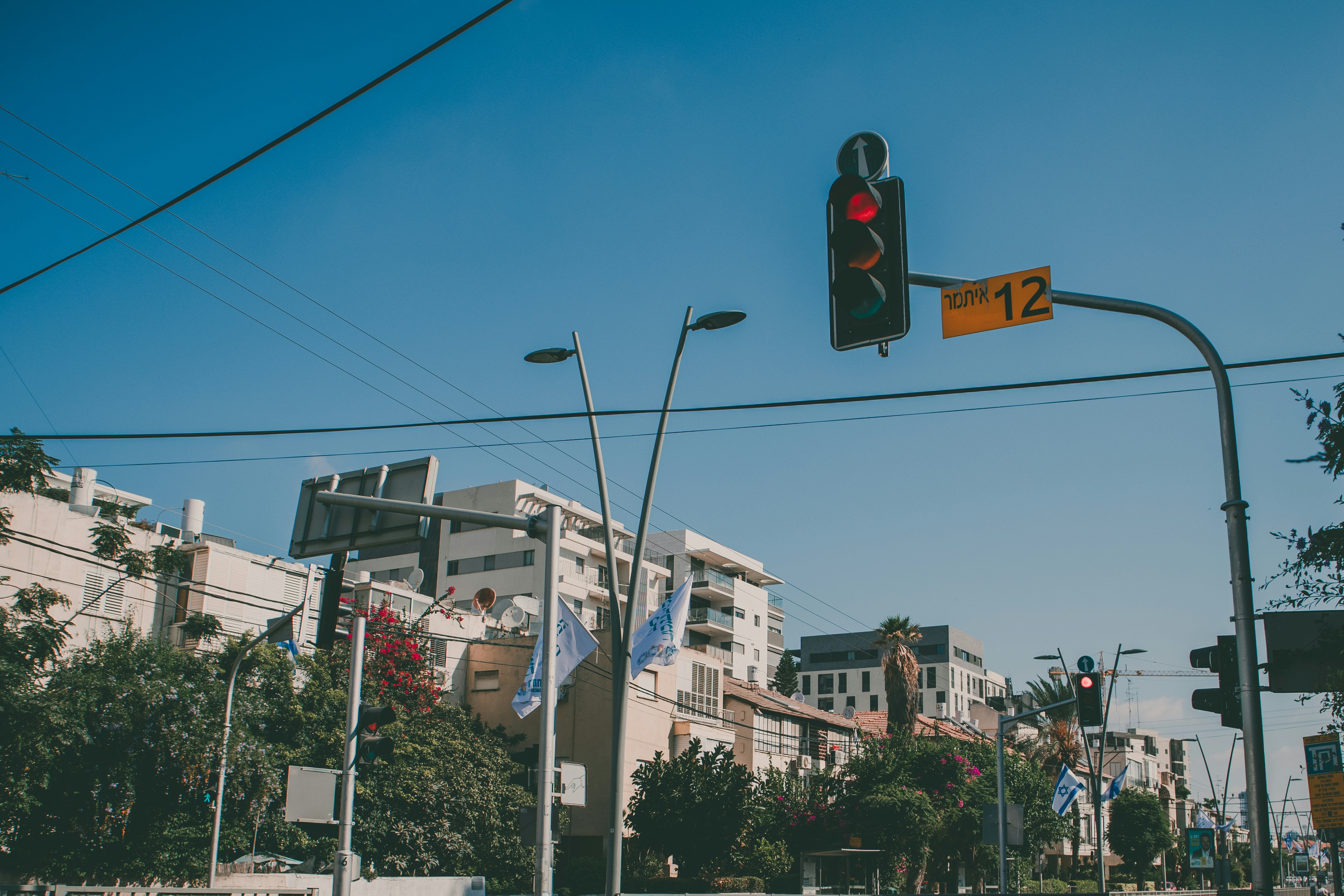 A traffic light hanging over a city street photo – Free Israel Image on ...