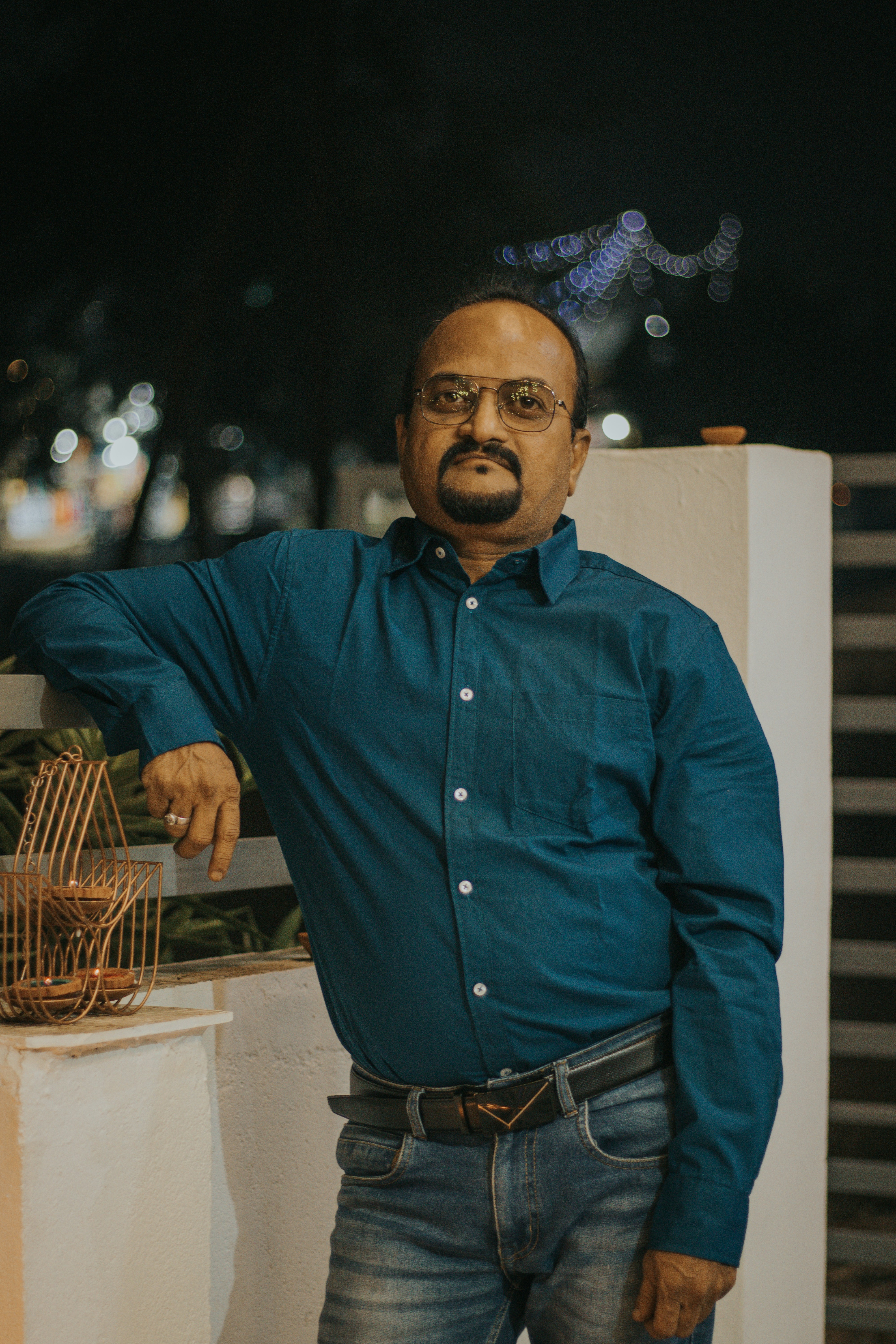Midnight Terrace Portrait: A poised figure in teal against city bokeh