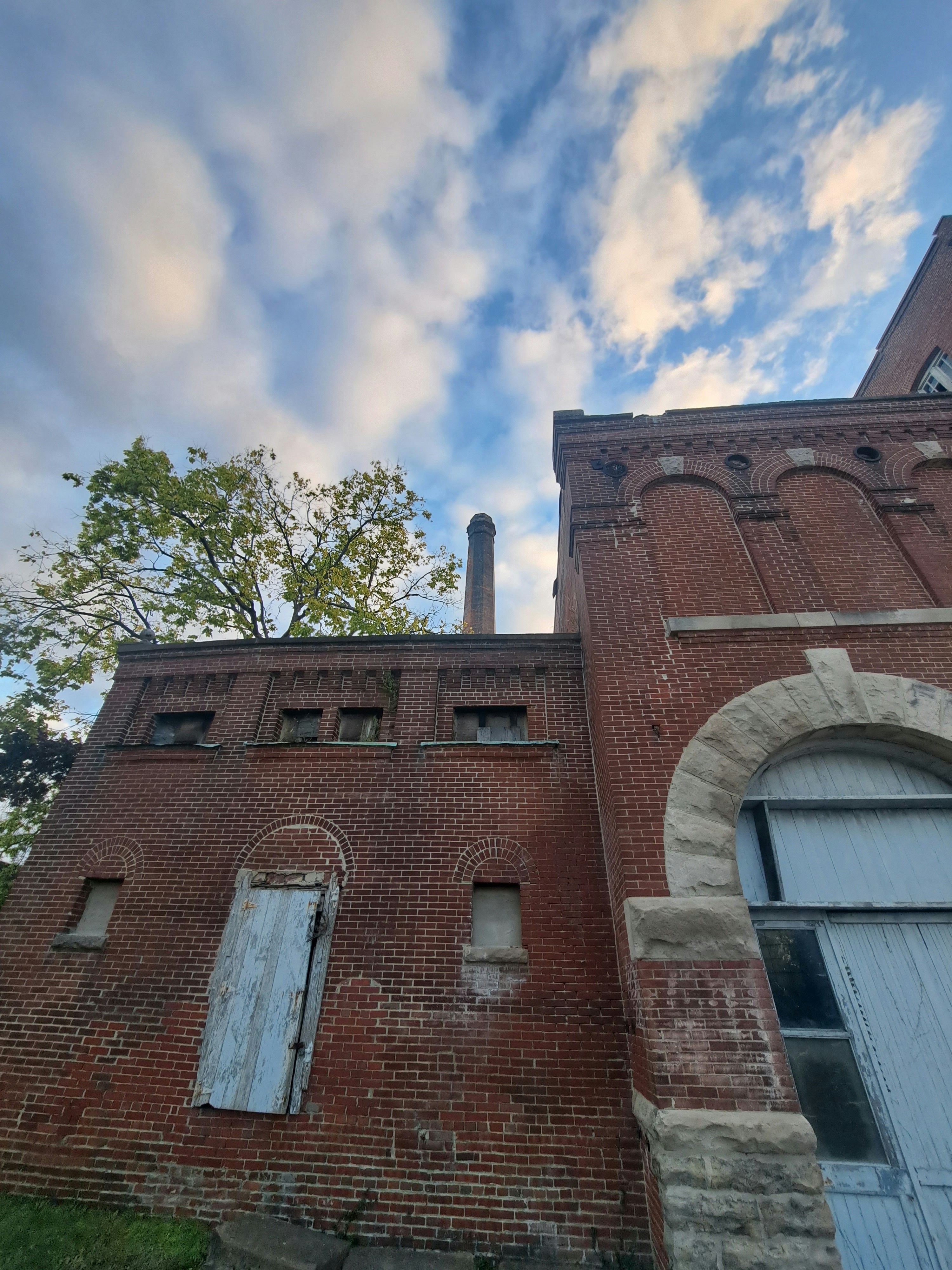Brickwork Reaches for the Sky: An Upward Gaze at a Weathered Industrial Wing