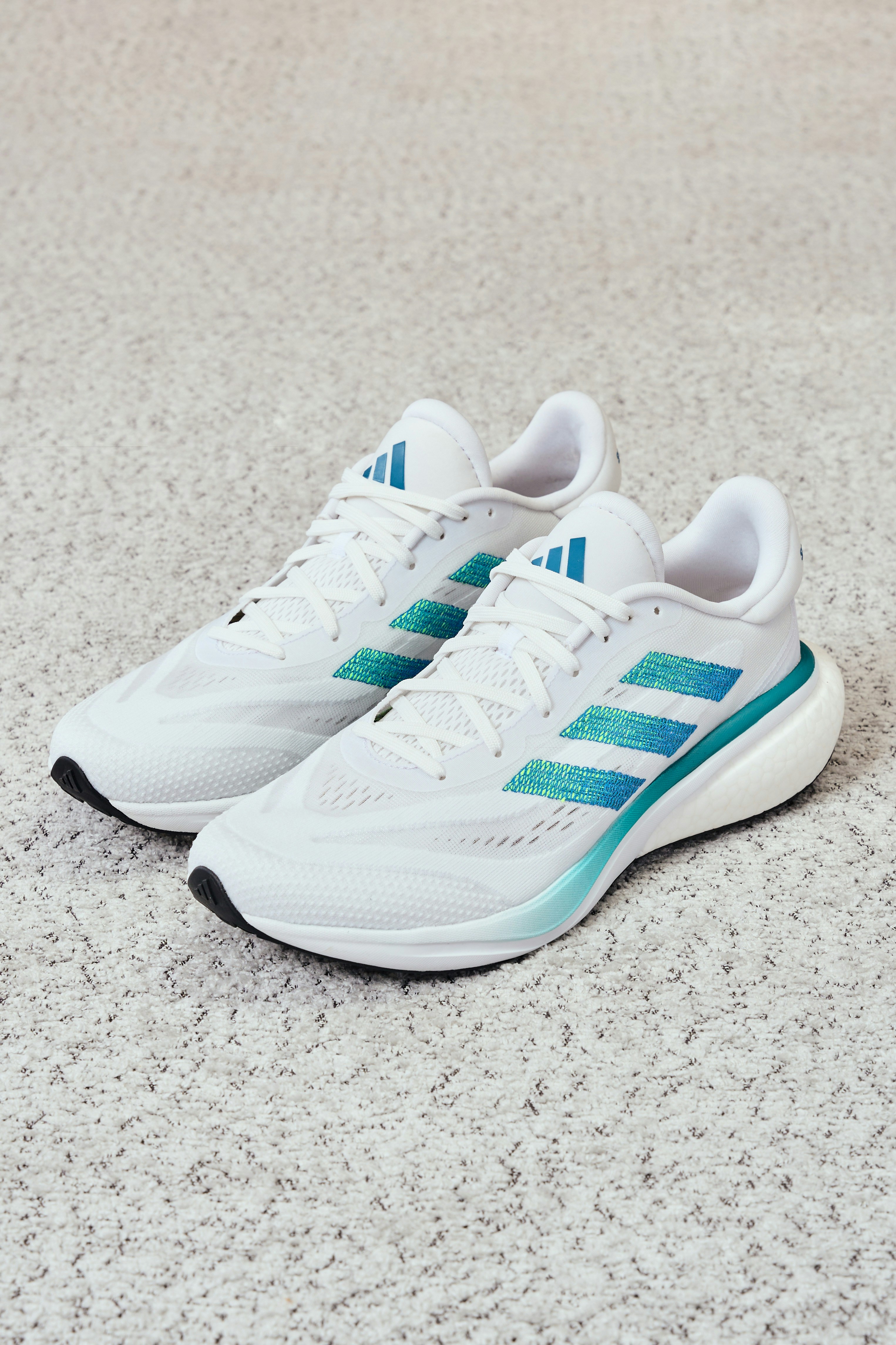 A pair of white and blue shoes on the ground photo – Free Shoe Image on ...