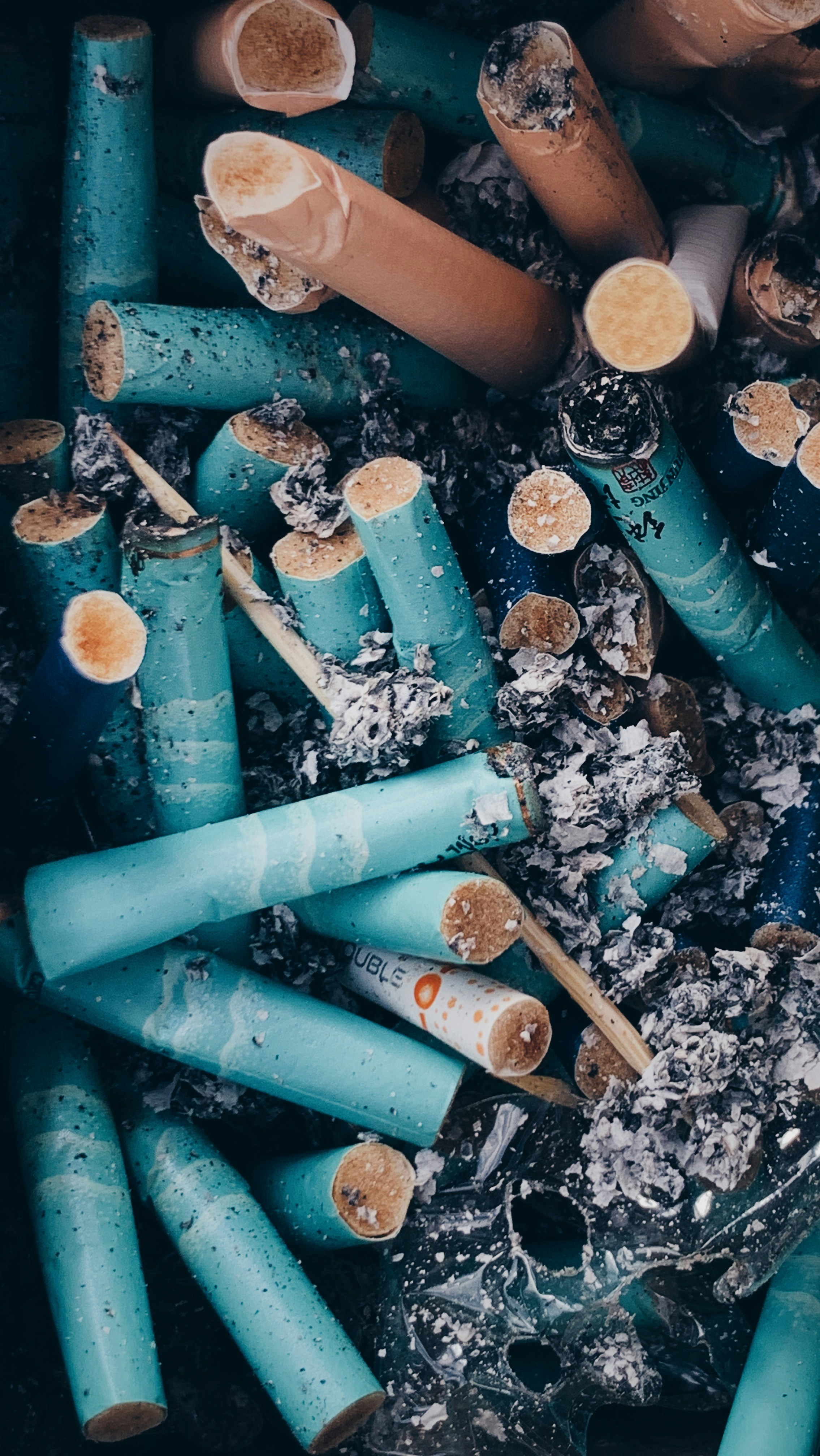 A pile of blue and brown cigarettes sitting next to each other photo ...