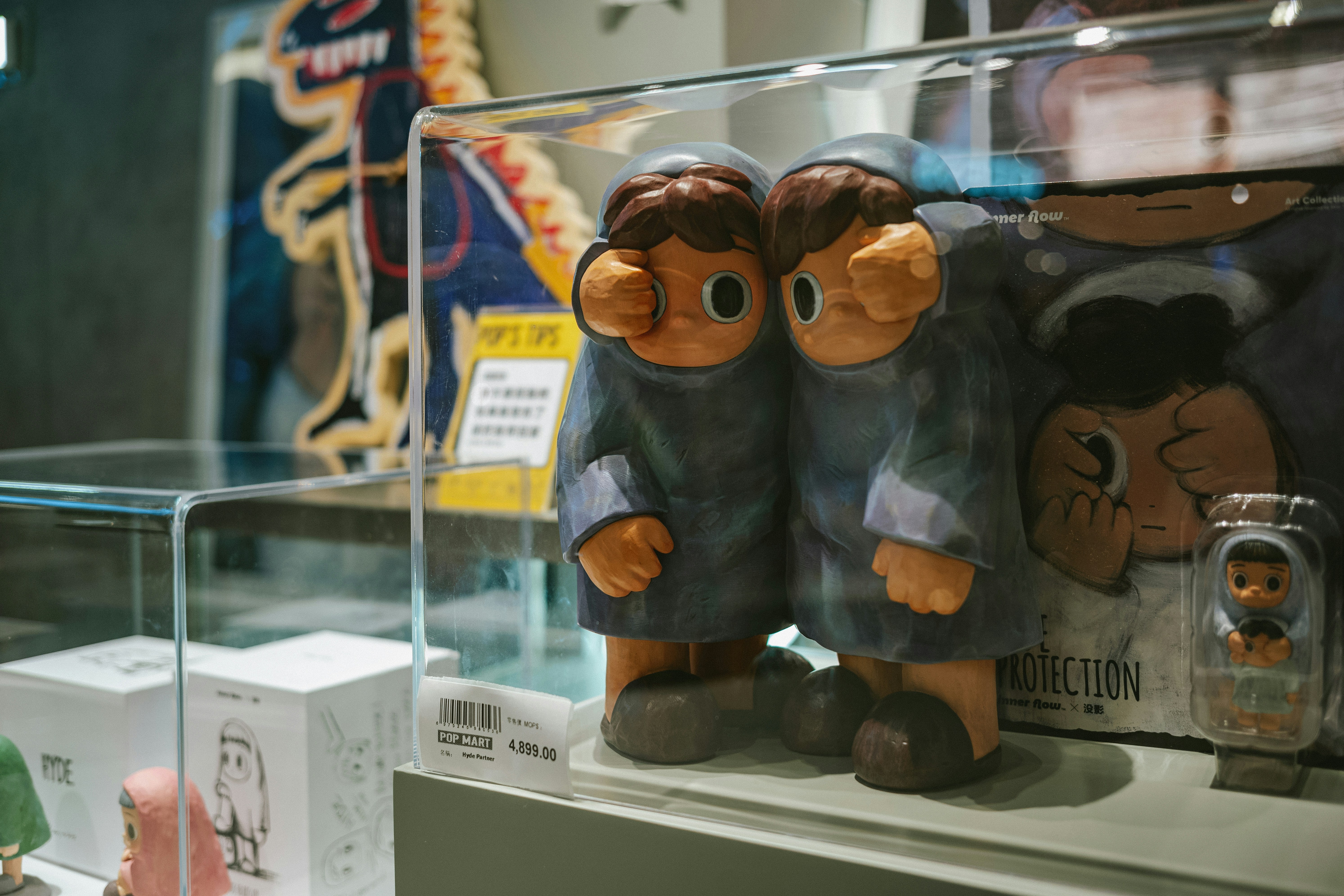 Two Toy Figures Guarding a Display Case