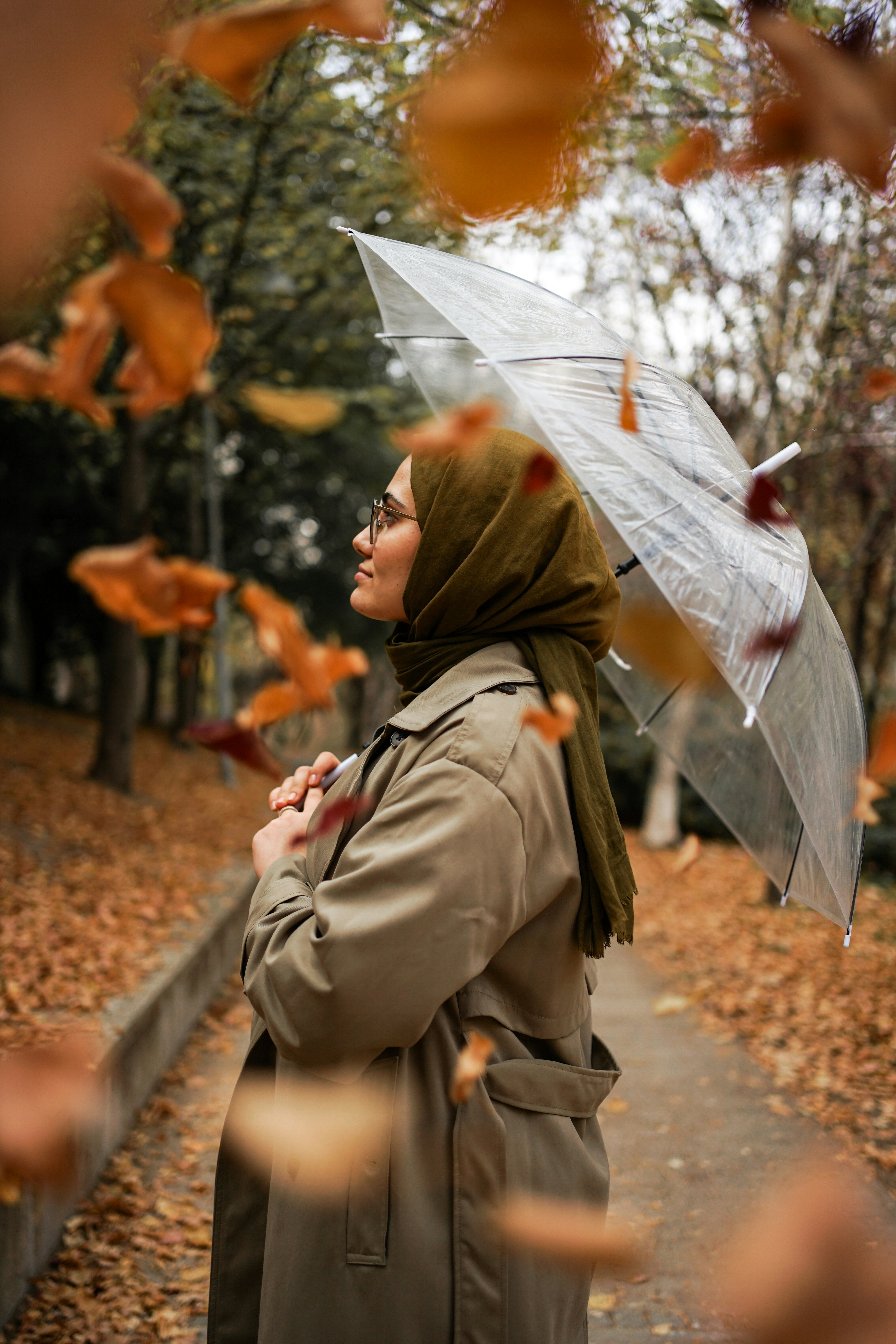 Harbinger of Autumn: A Quiet Portrait Under an Umbrella