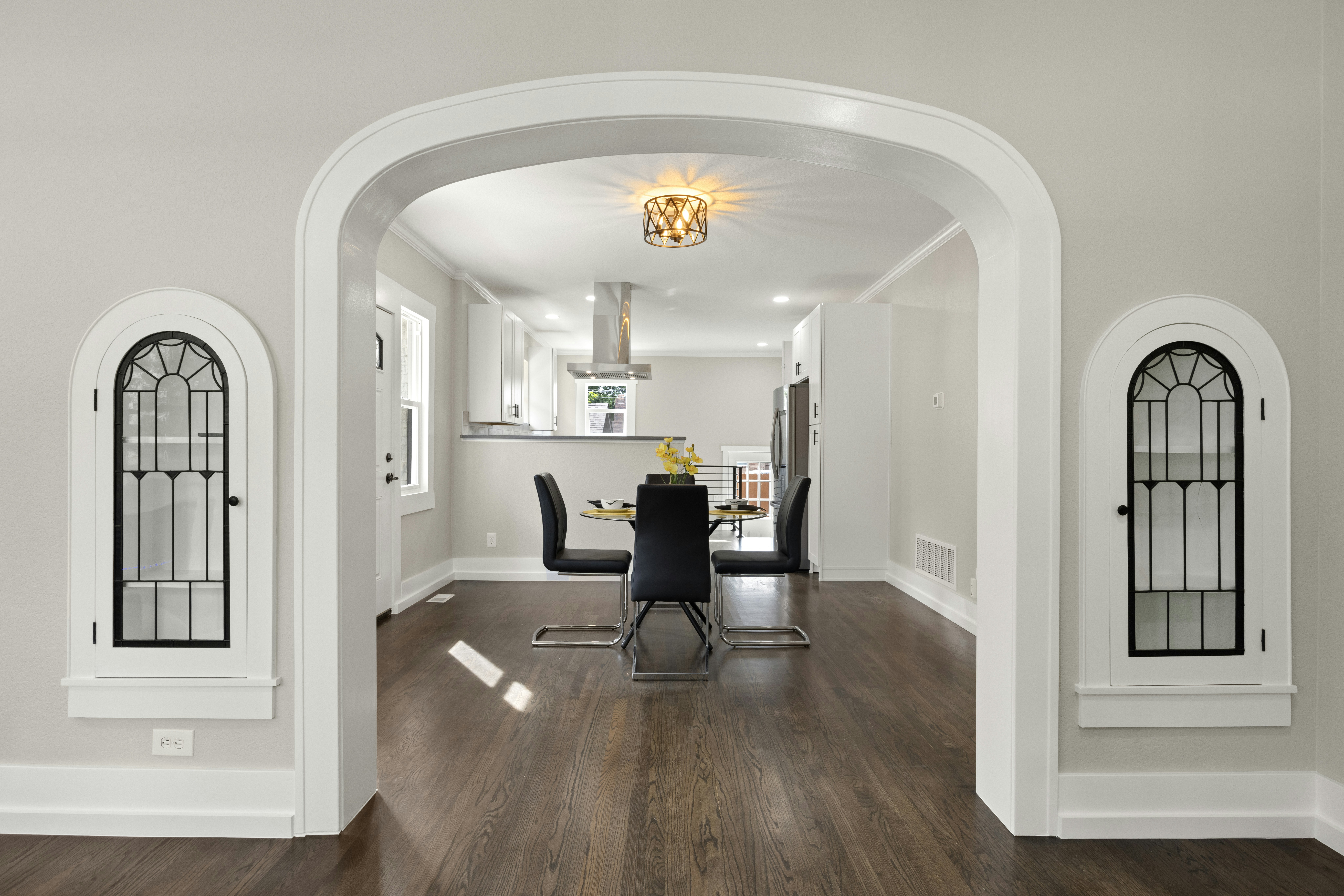 Symmetry in Light: Archways Framing a Sunlit Dining Nook