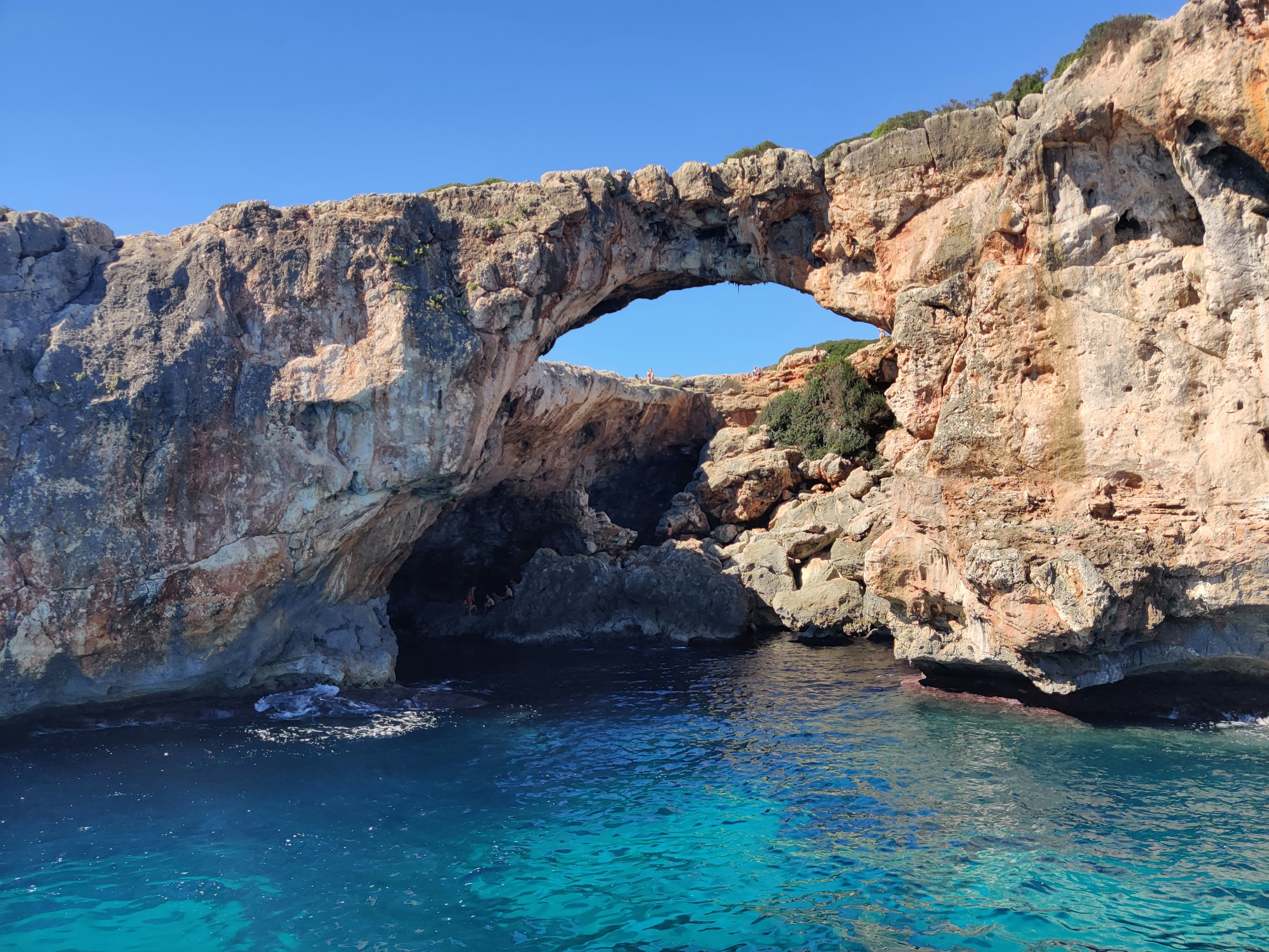 A rock arch over a body of water photo – Free Mallorca Image on Unsplash