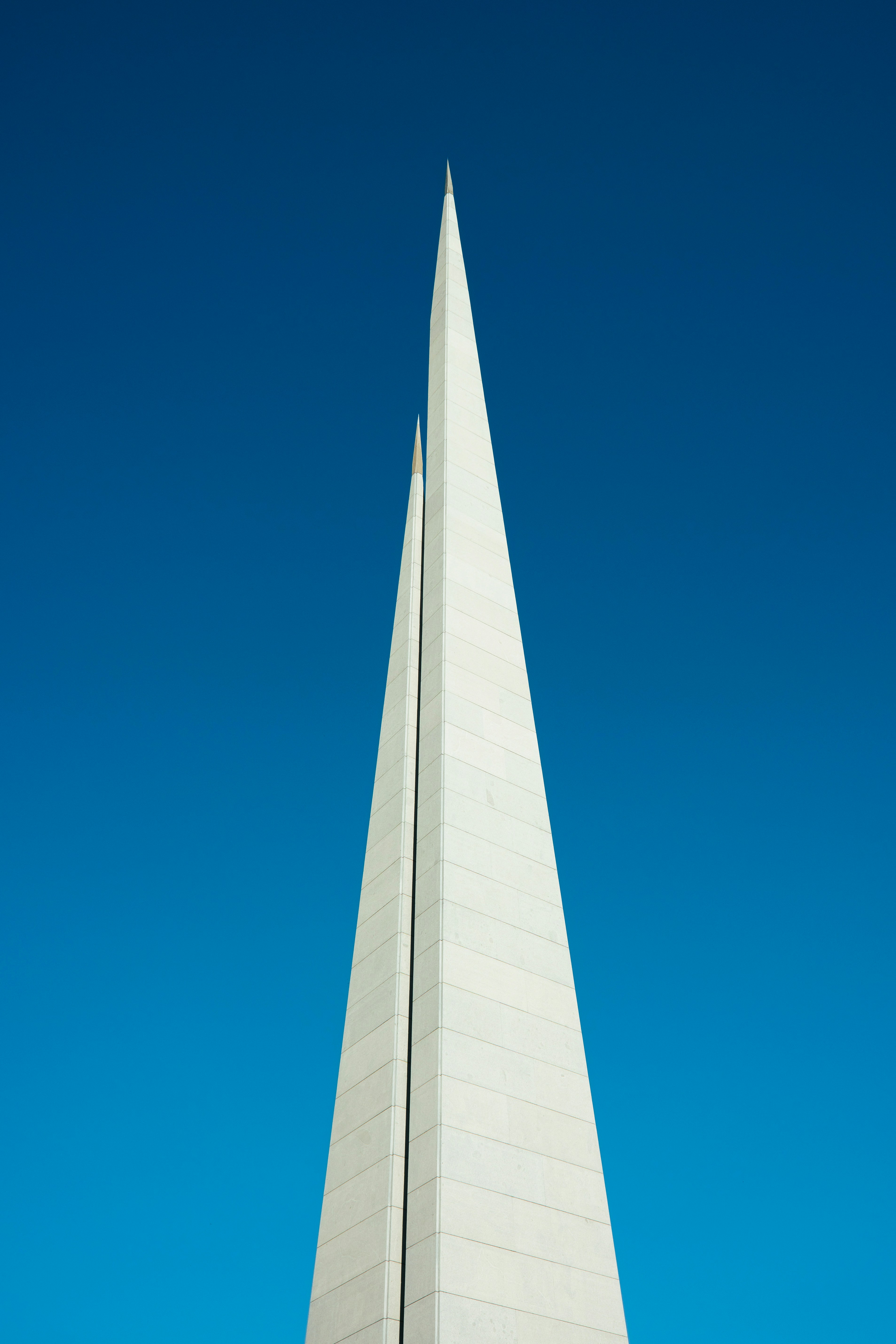 A very tall building with a very tall spire photo – Free Blue Image on ...