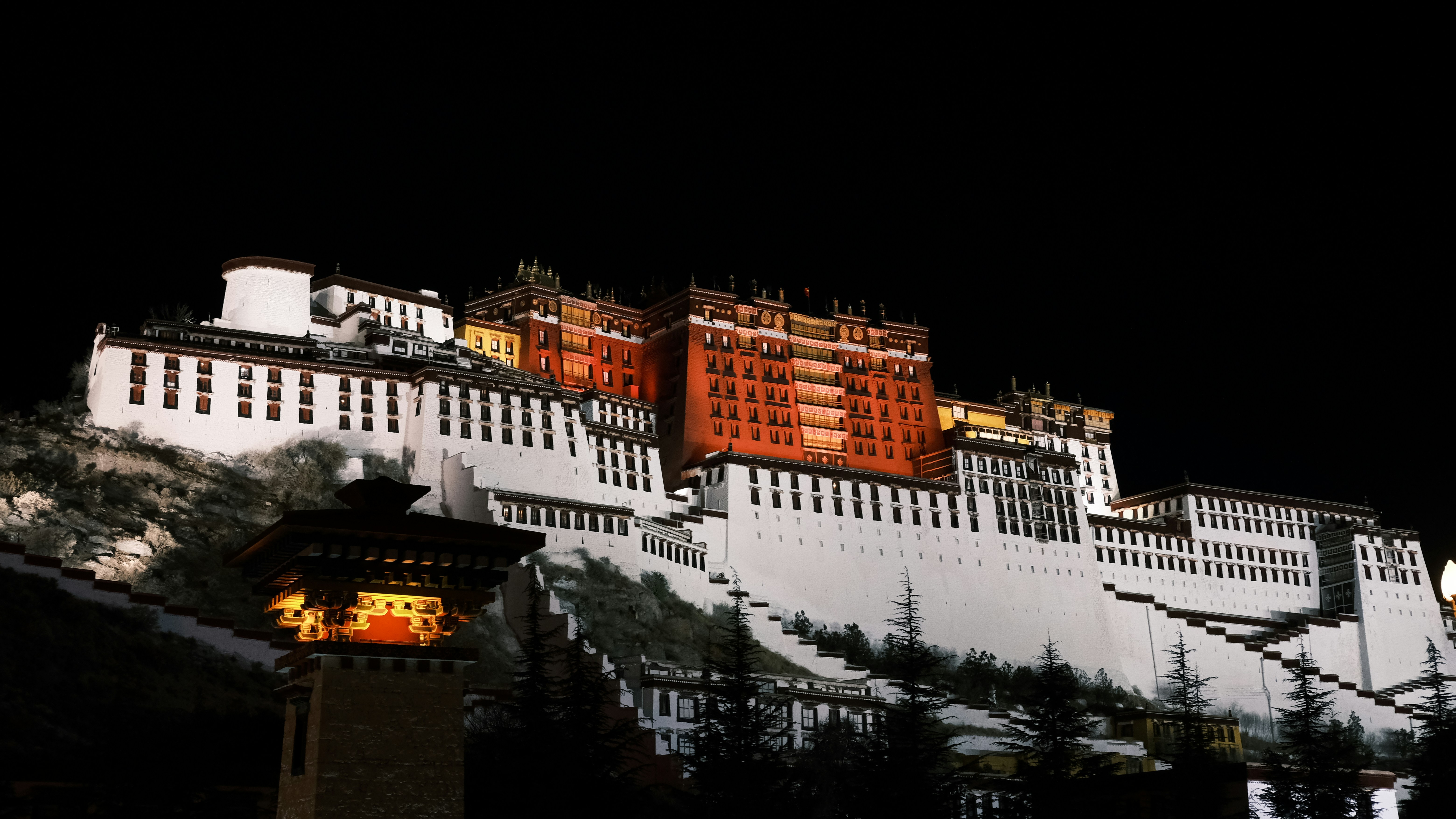 Nightfall Citadel: White Walls and Red Towers Crowned by Lights