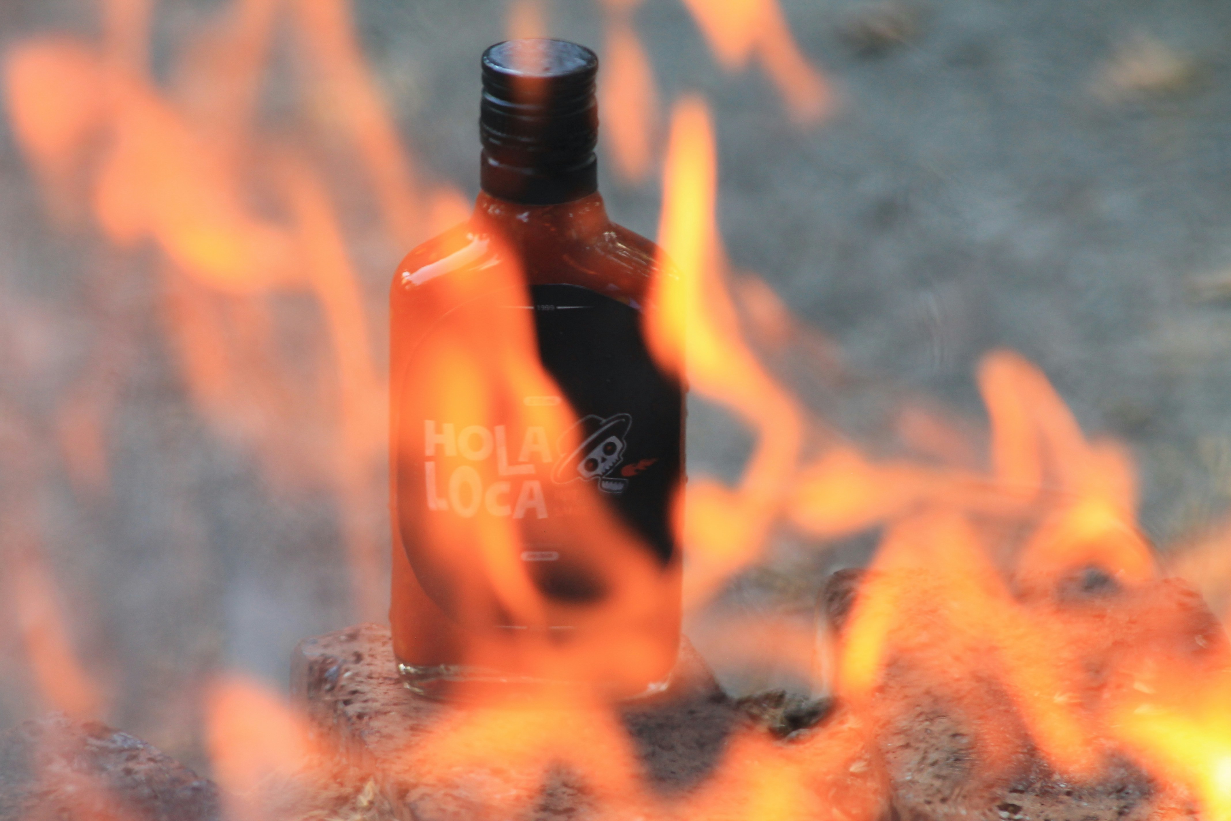 Luminous Inferno: A Bottle Surrounded by Garden-Scale Flames