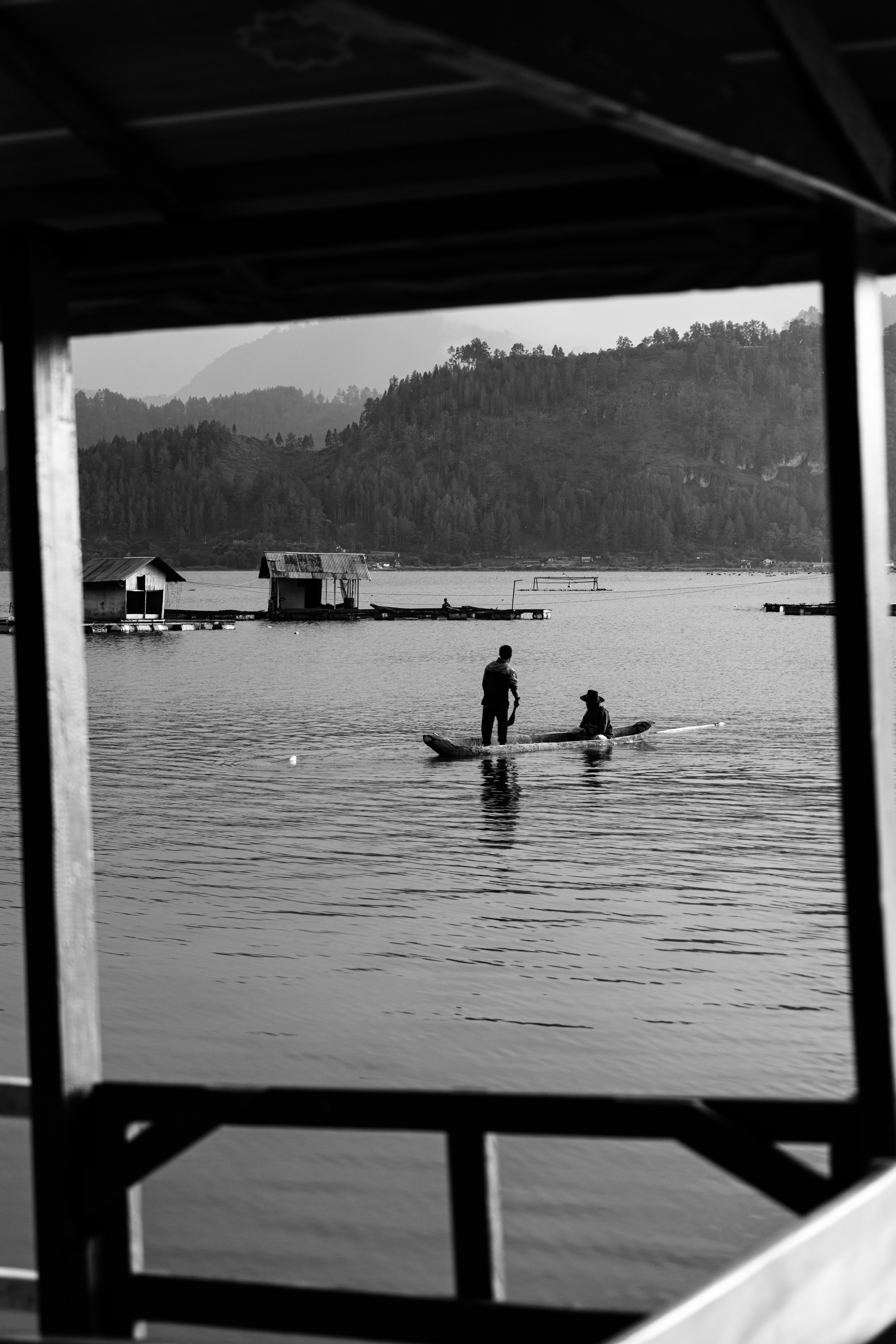 Framed Silence: Two Figures in a Canoe on a Mirror Lake