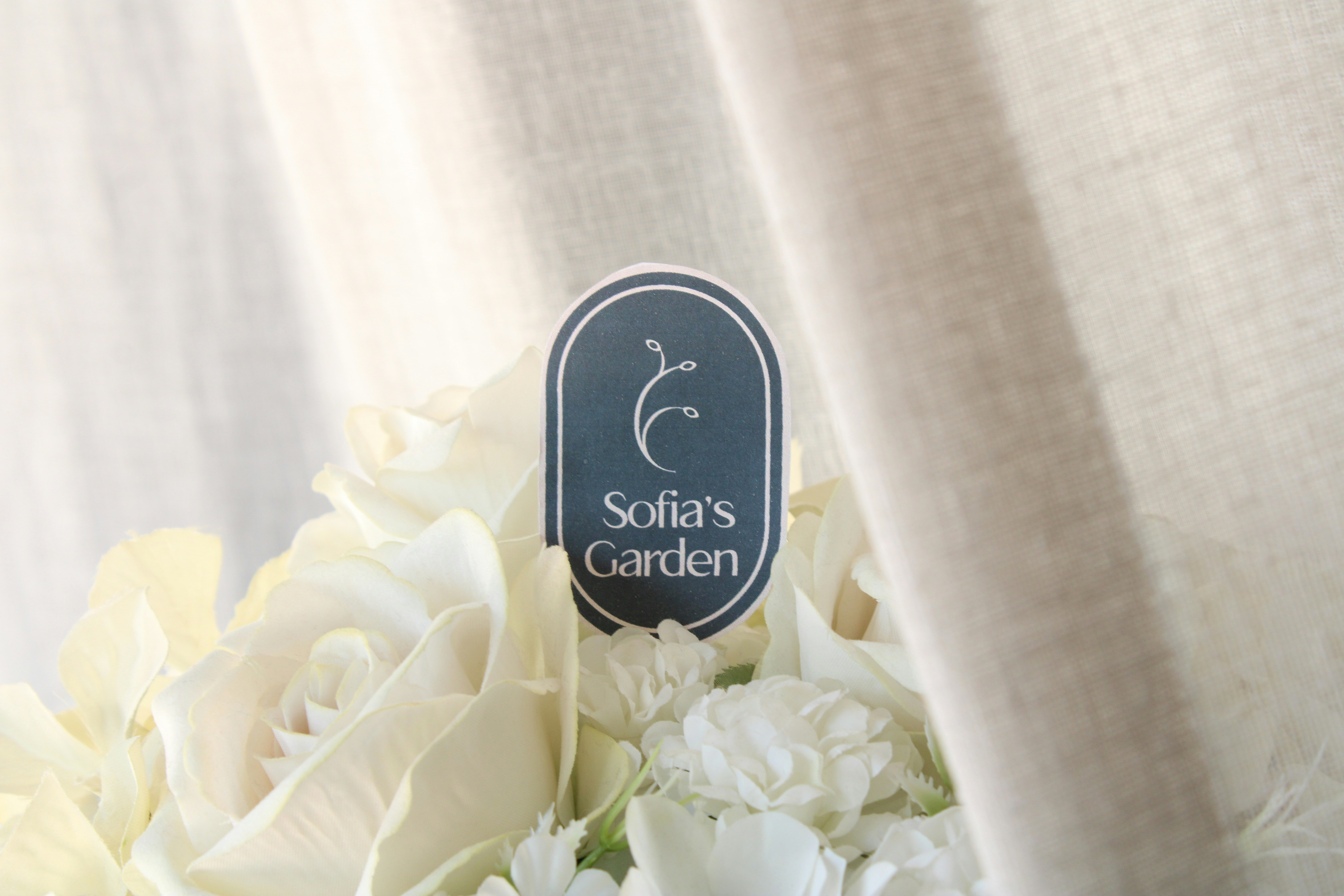 Sofia’s Garden: Ivory Roses Cradled by Soft Drapes