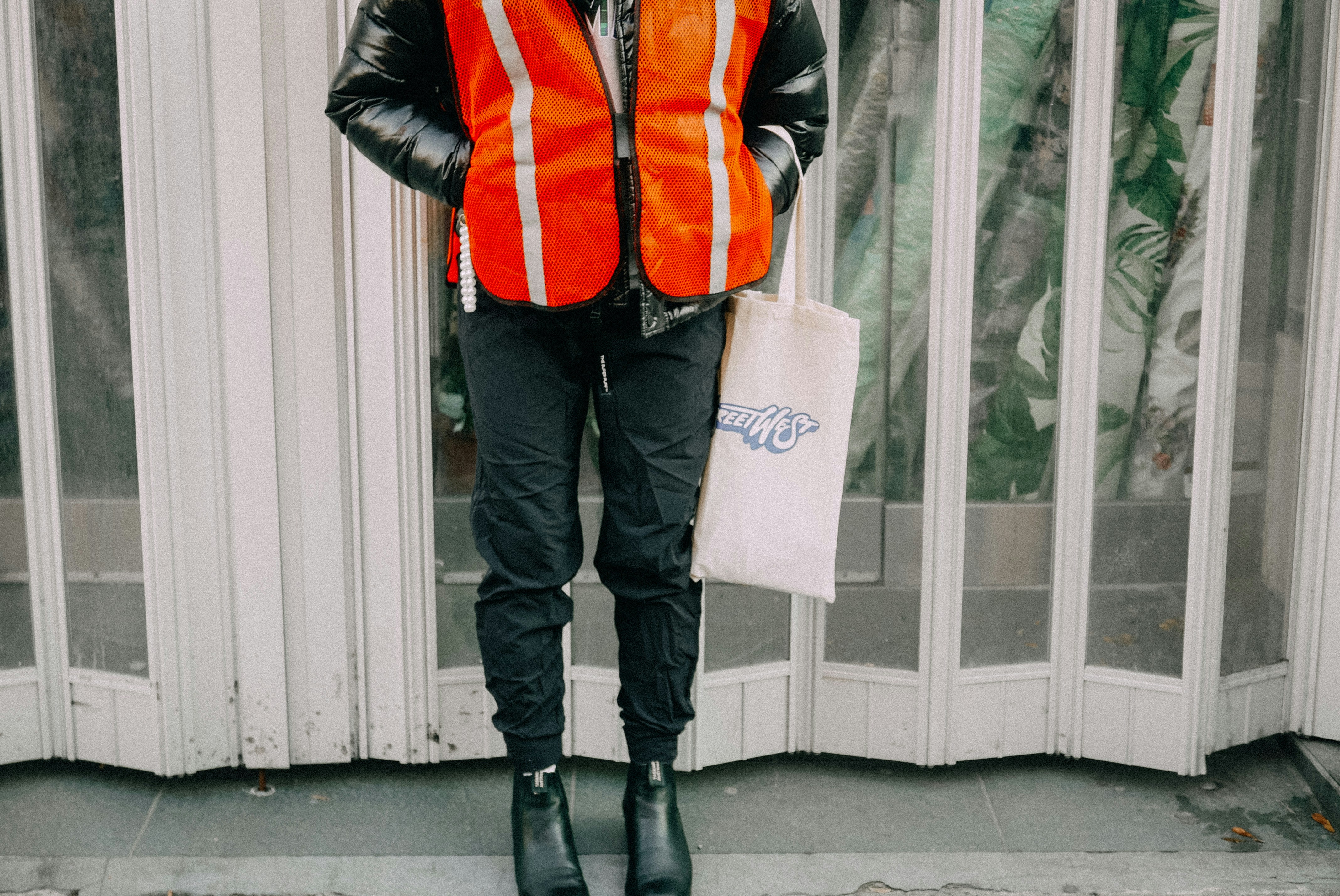 Neon-Orange Safety Vest at a Glass-Front Entrance