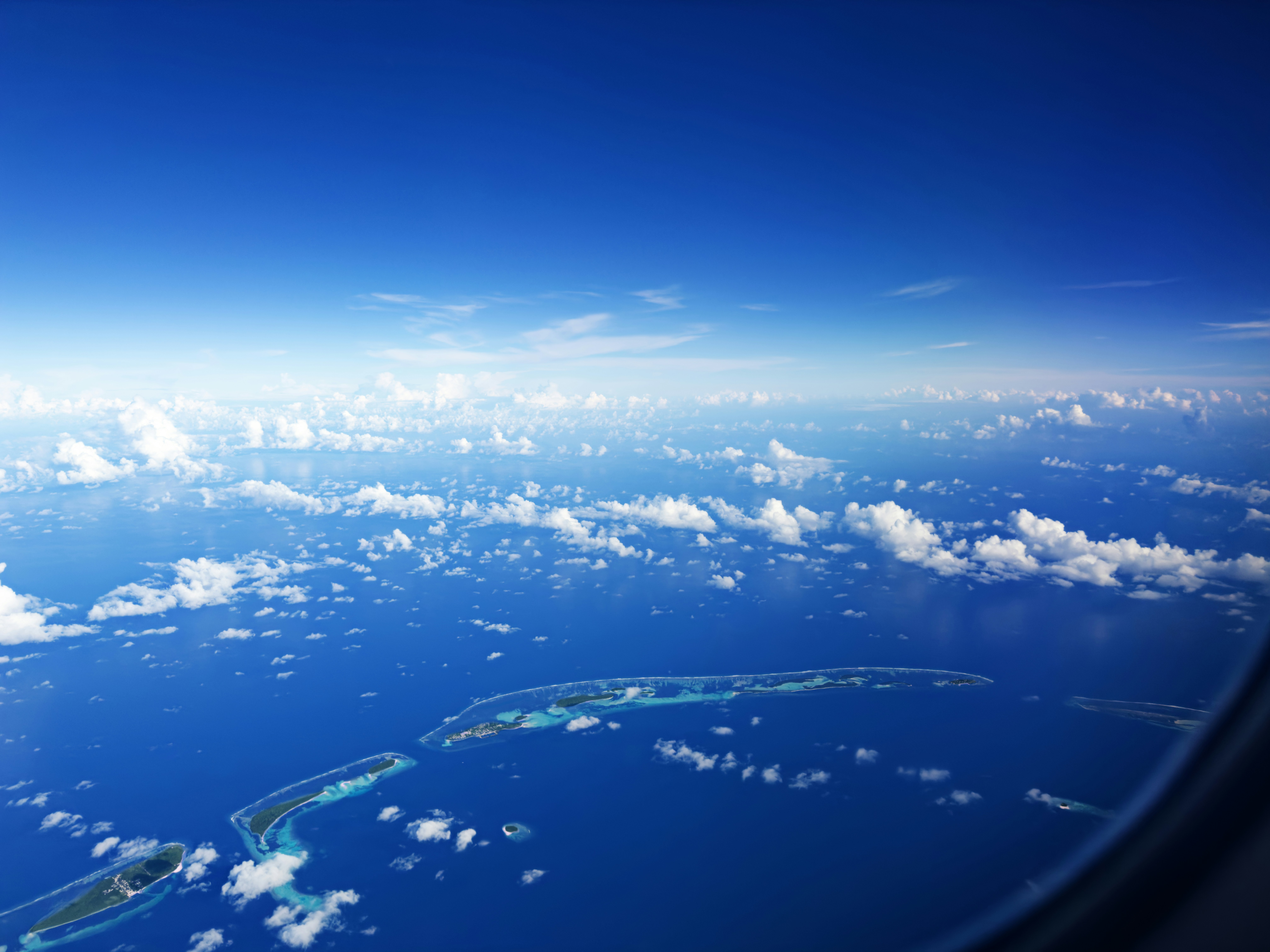 Aerial Atolls and Sapphire Sea: Islands Cresting the Ocean