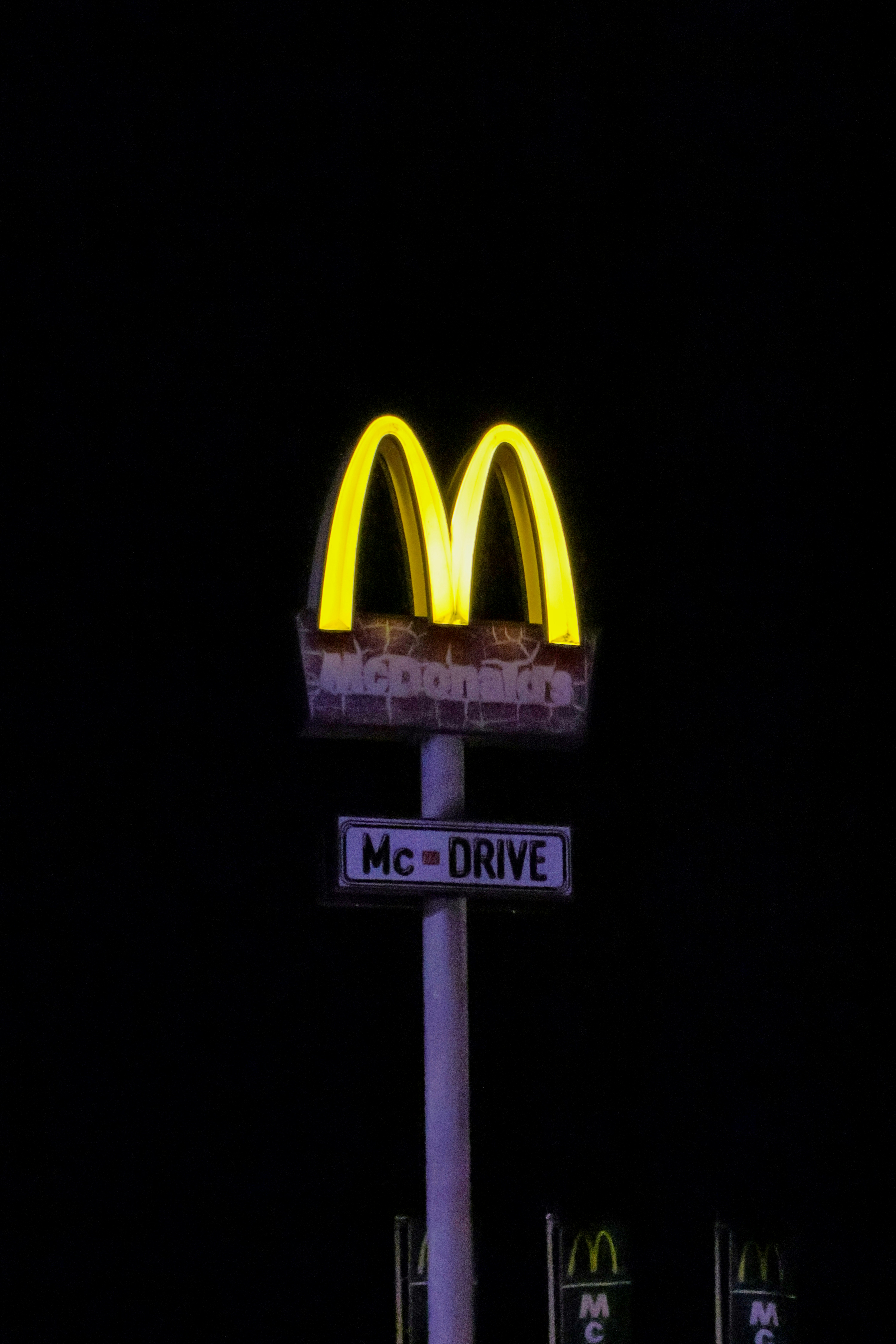 A mcdonald's drive sign lit up at night photo – Free Night Image on ...